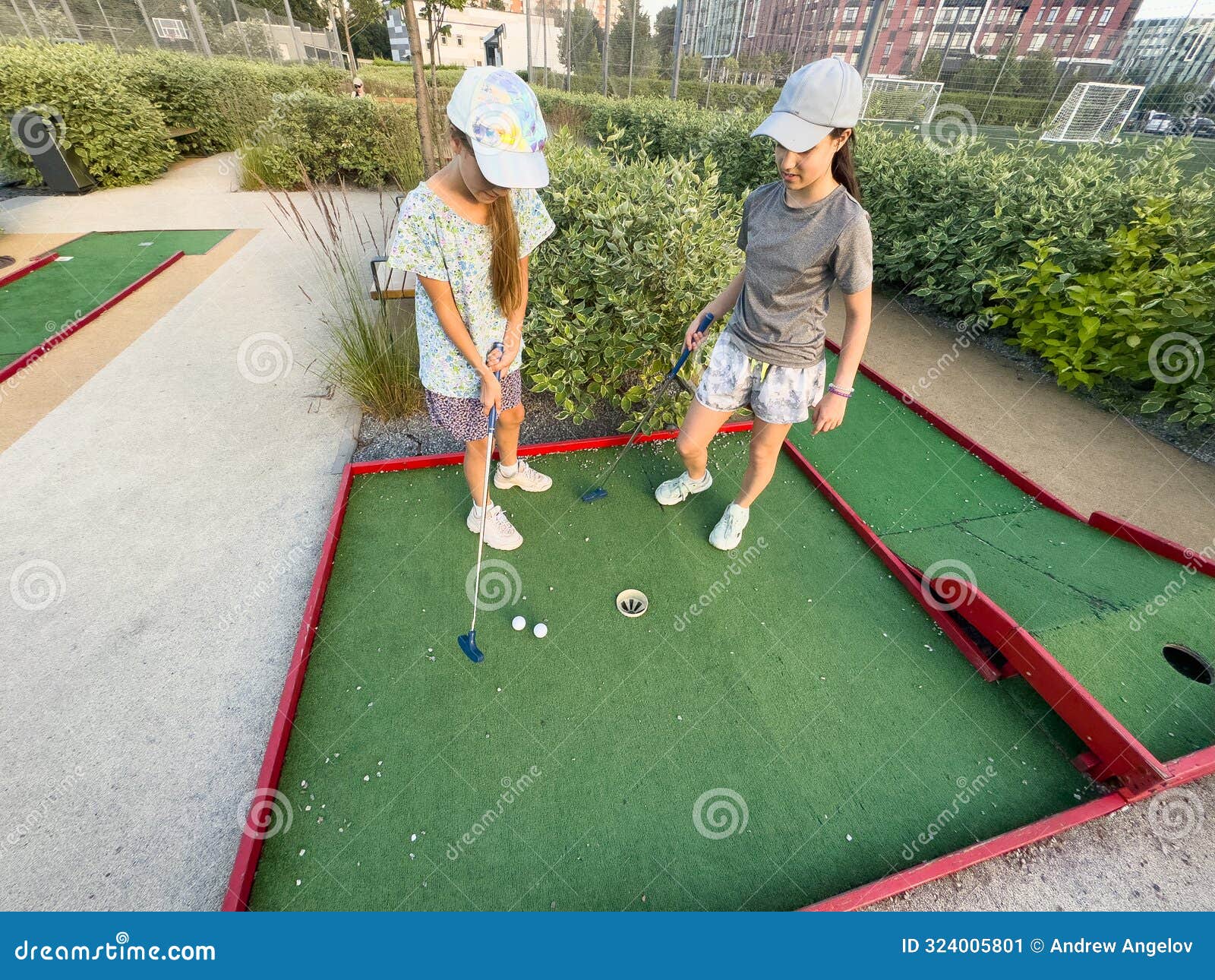 Cute Little Girl on a Miniature Golf Course Stock Image - Image of putt ...