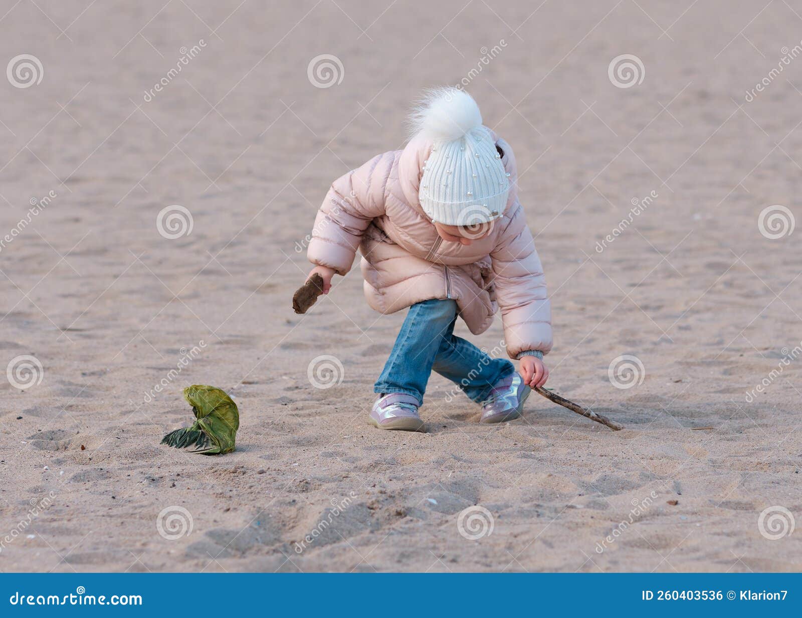 Cute Little Girl is Playing on an Empty Beach on a Cold Day Stock Photo ...