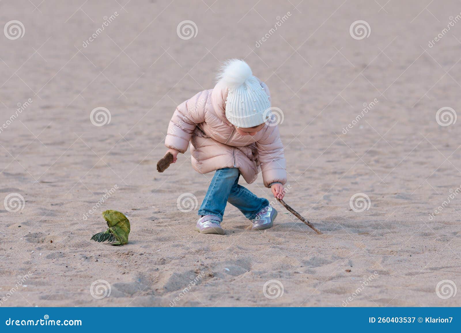 Cute Little Girl is Playing on an Empty Beach on a Cold Day Stock Image ...