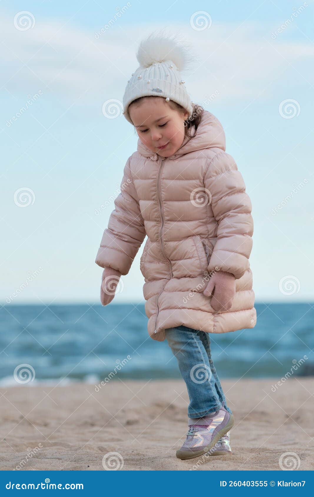 Cute Little Girl is Playing on an Empty Beach on a Cold Day Stock Image ...