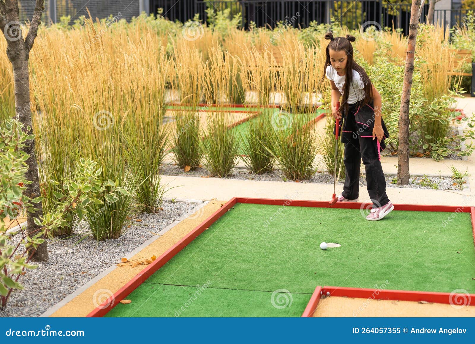 Cute Little Girl Playing Mini Golf in a Park. Stock Image - Image of ...