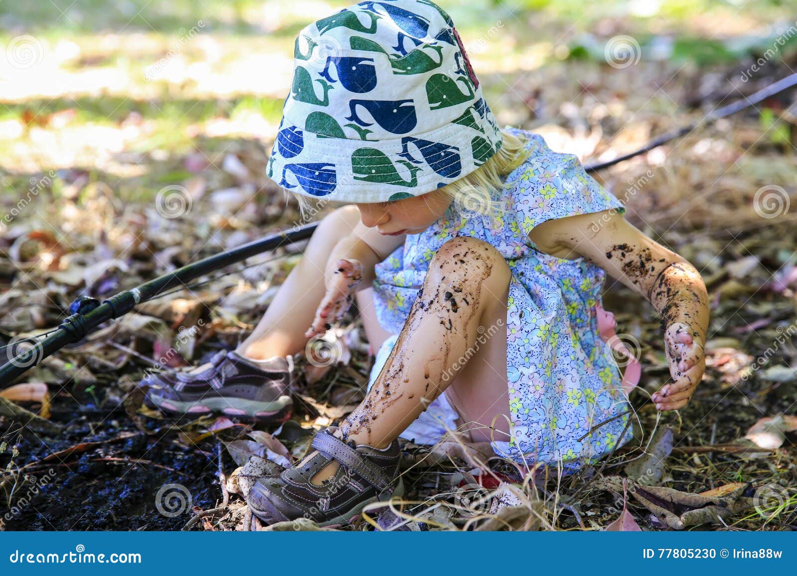 Cute Little Girl is Sitting on the Ground , Playing in Mud Stock Photo ...