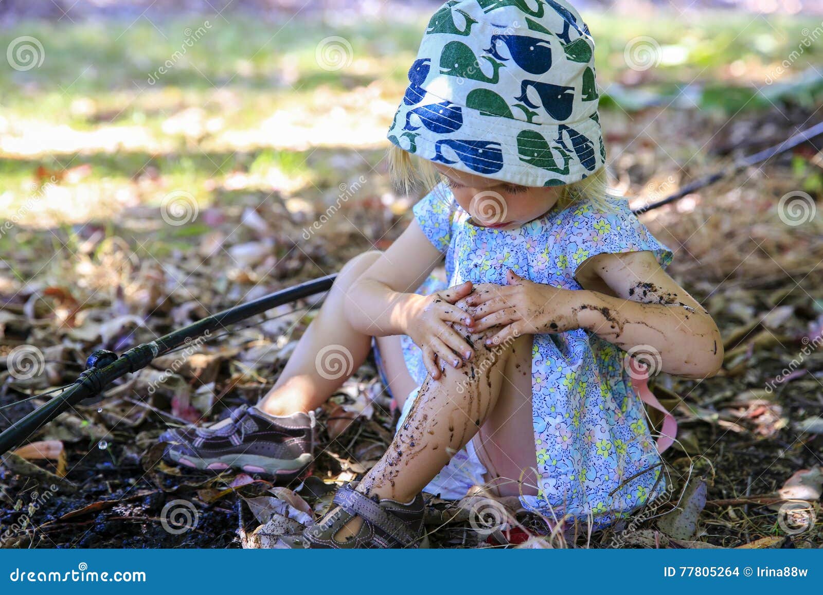 Cute Little Girl is Sitting on the Ground , Playing in Mud Stock Photo ...