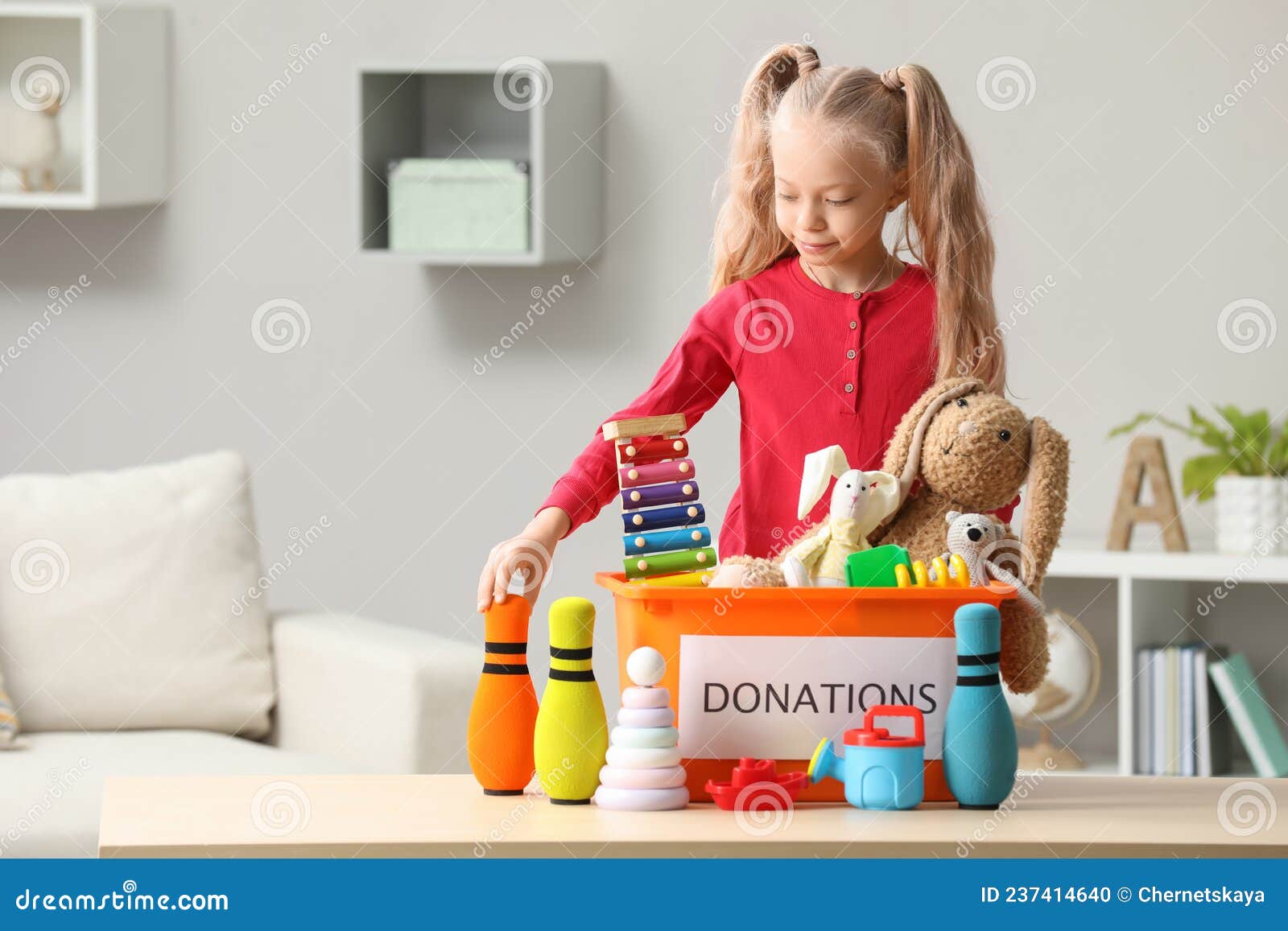 Cute Little Girl Sorting Donation Box at Home Stock Photo - Image of ...