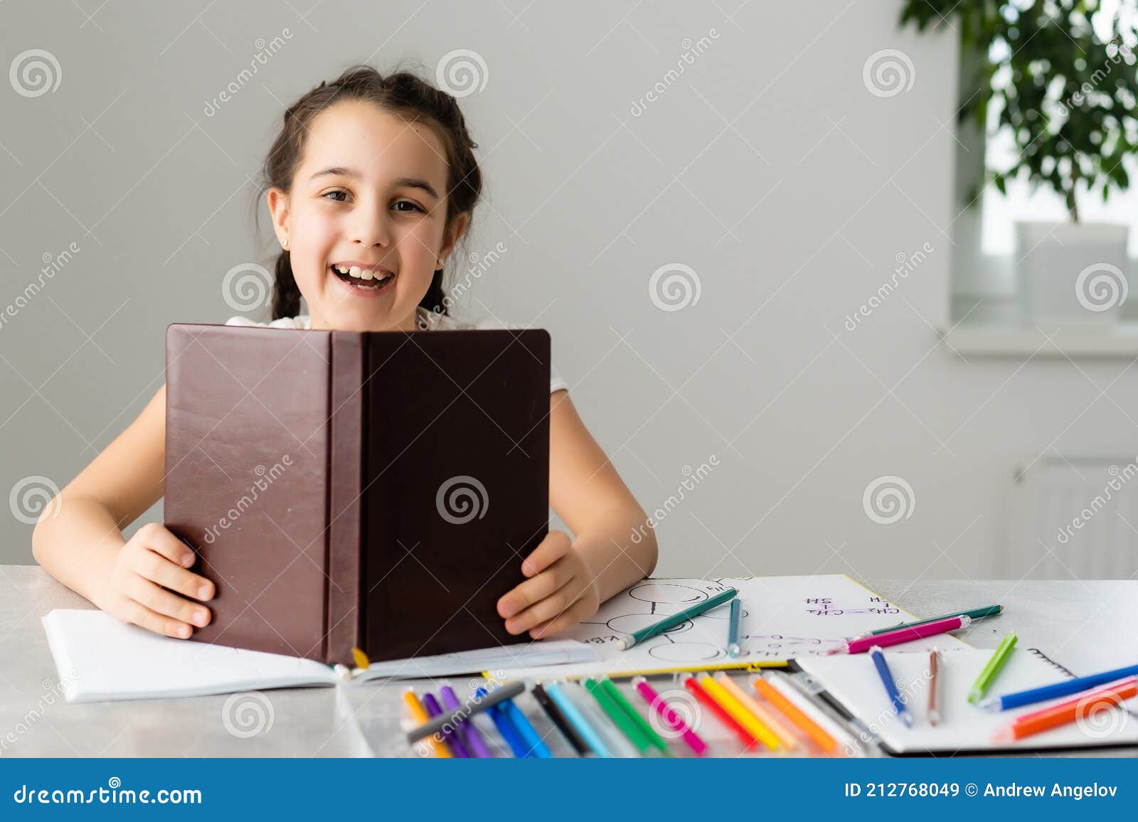Cute Little Girl Studying at Home and Smiling Stock Image - Image of ...