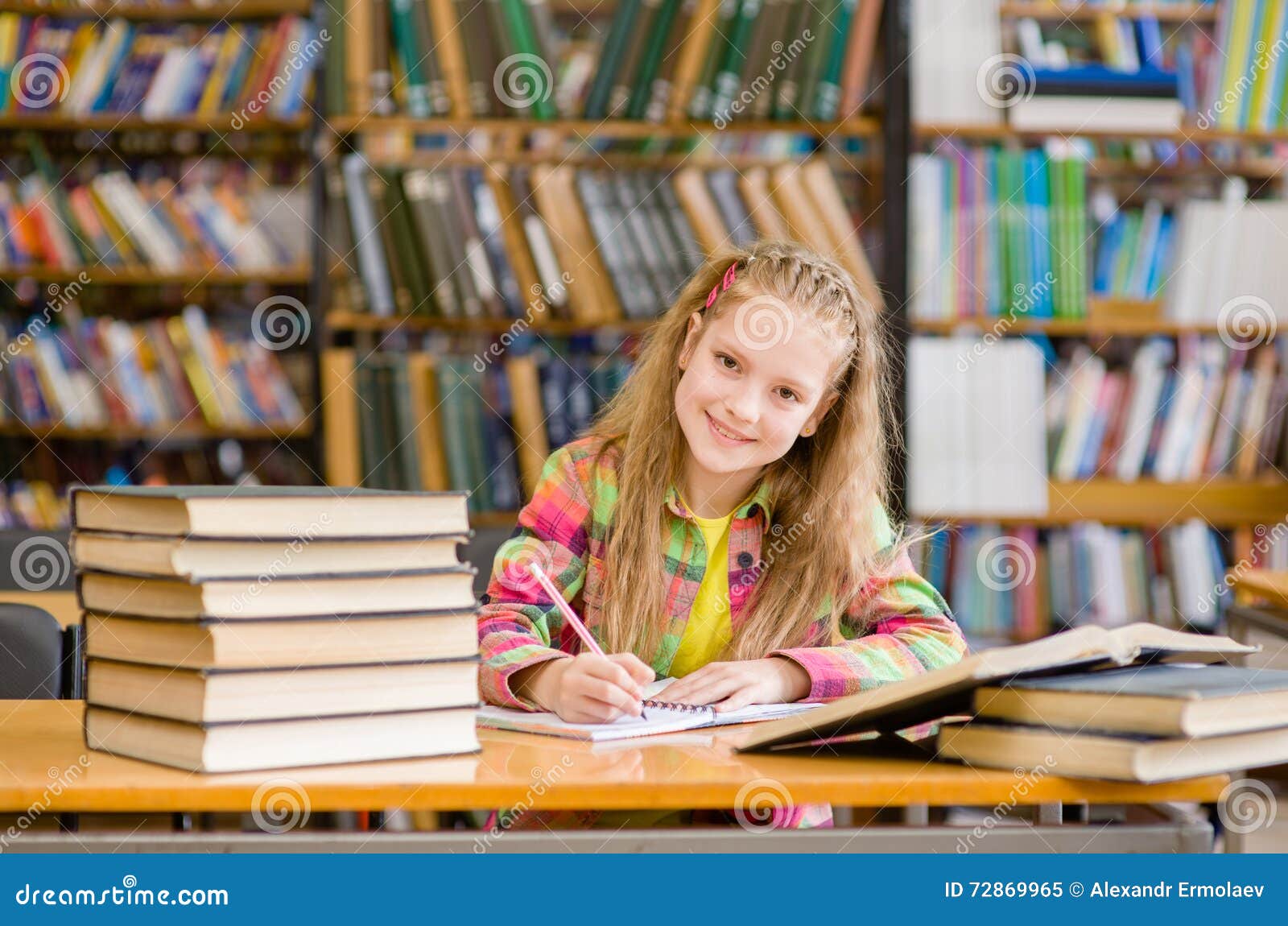 Cute Little Girl Studying at the Library and Smiling Stock Image ...