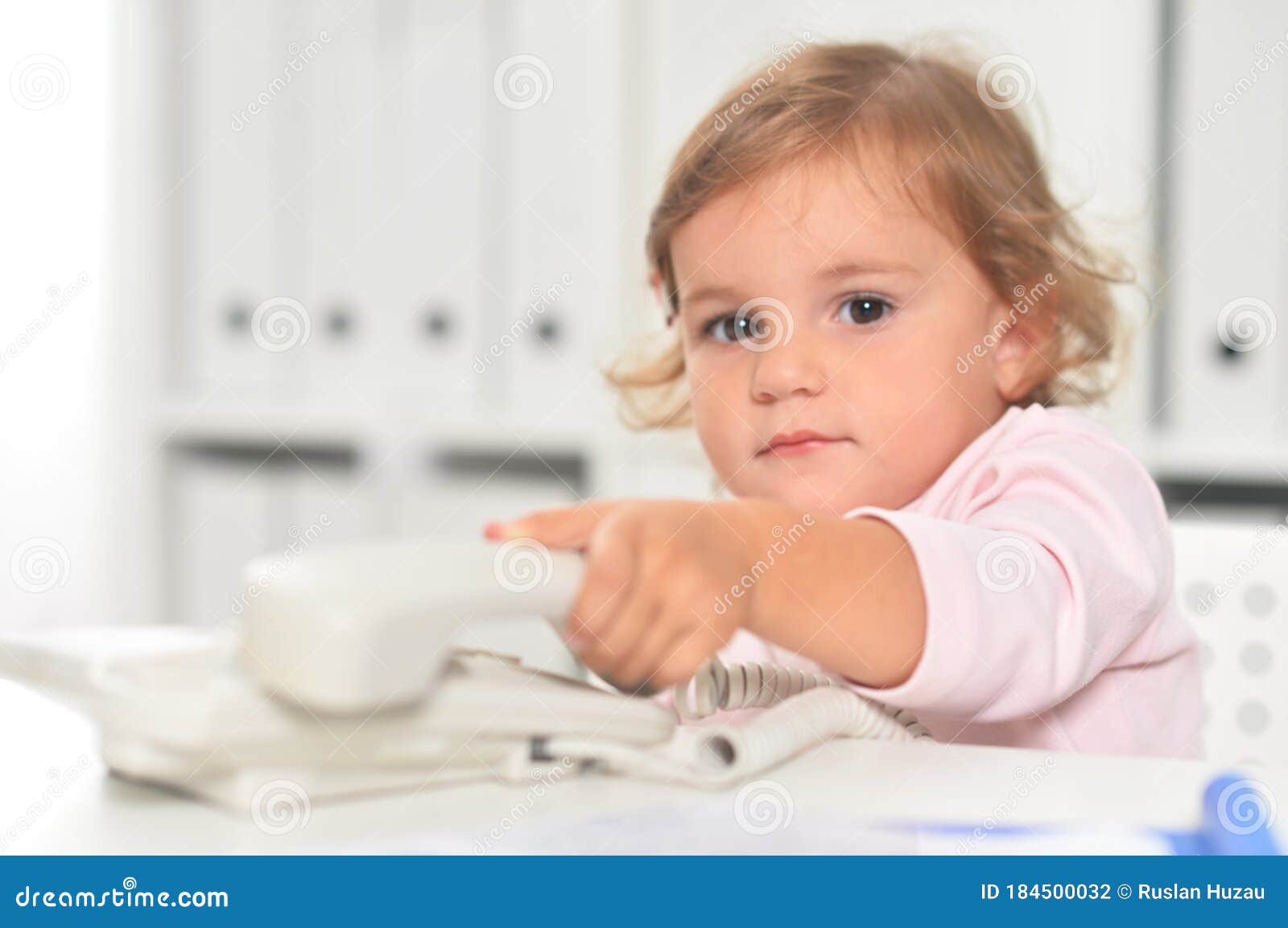 Cute Little Girl Using Phone in Office Stock Photo - Image of device ...