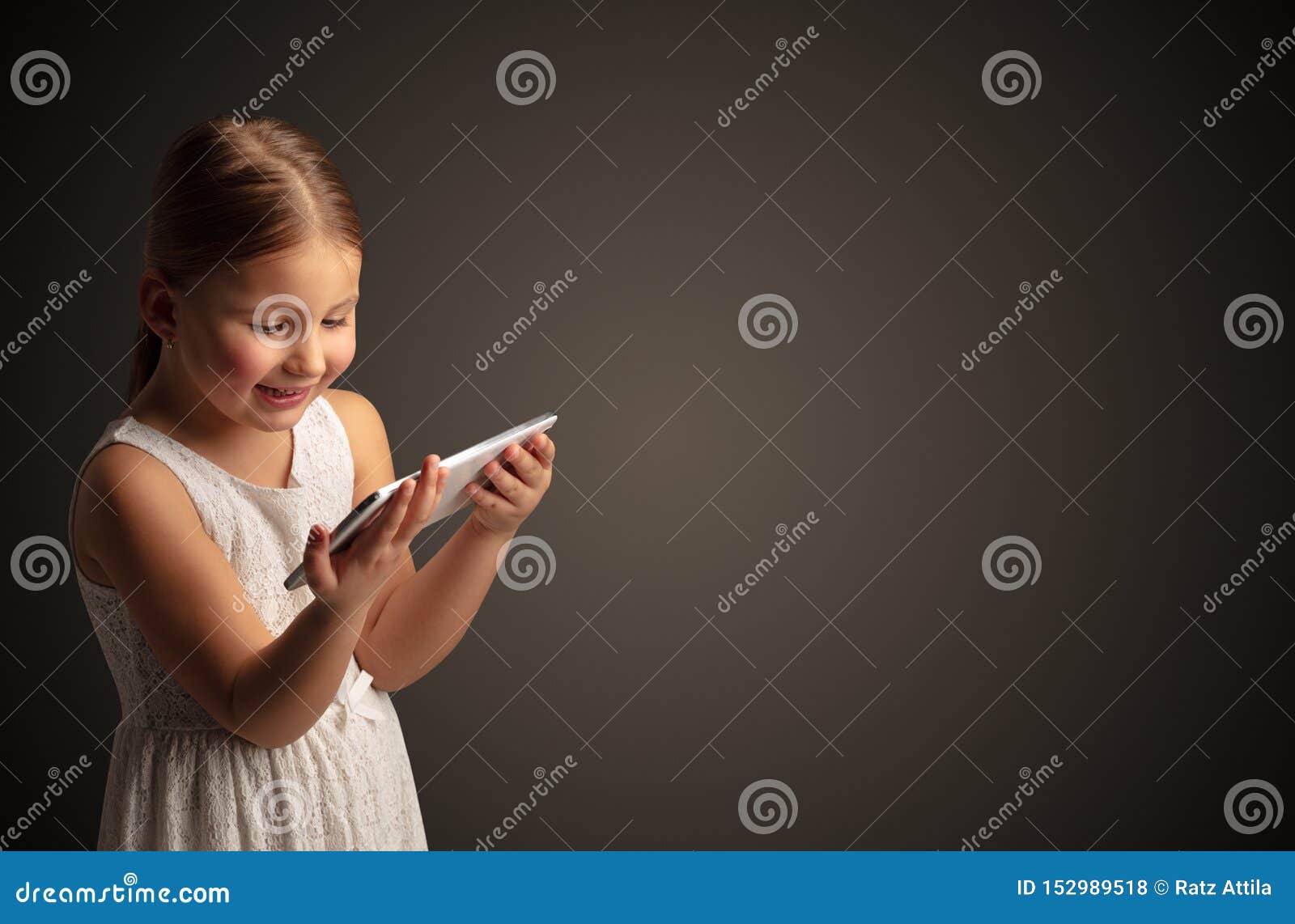 Cute Little Girl Using Tablet with Dark Background Stock Photo - Image ...