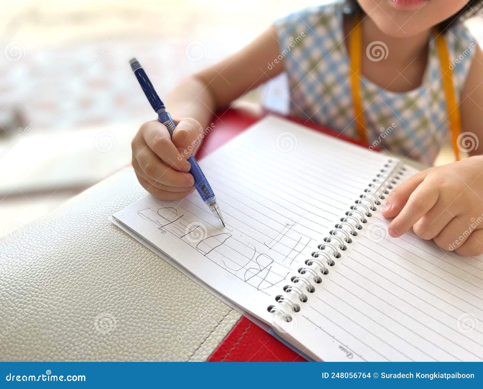Cute Little Girl Writes on Her Notebook Stock Photo - Image of design ...