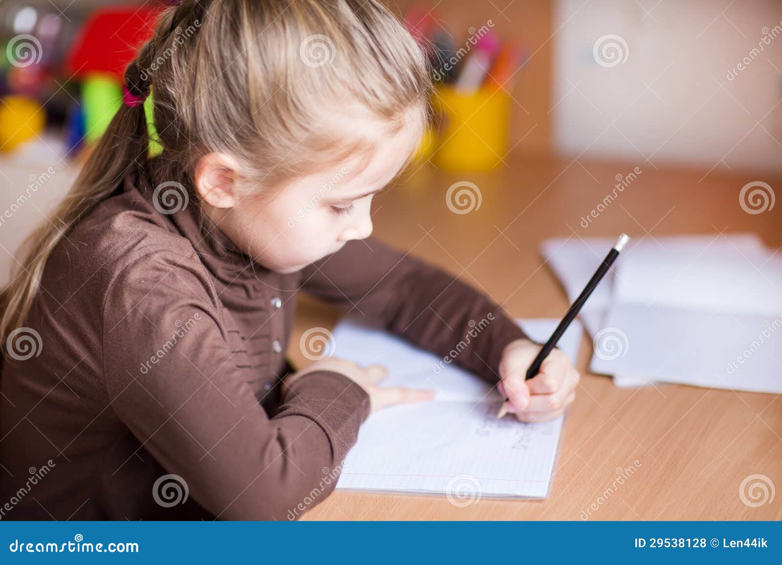 Cute Little Girl Writing Her Homework Stock Photo - Image of play ...