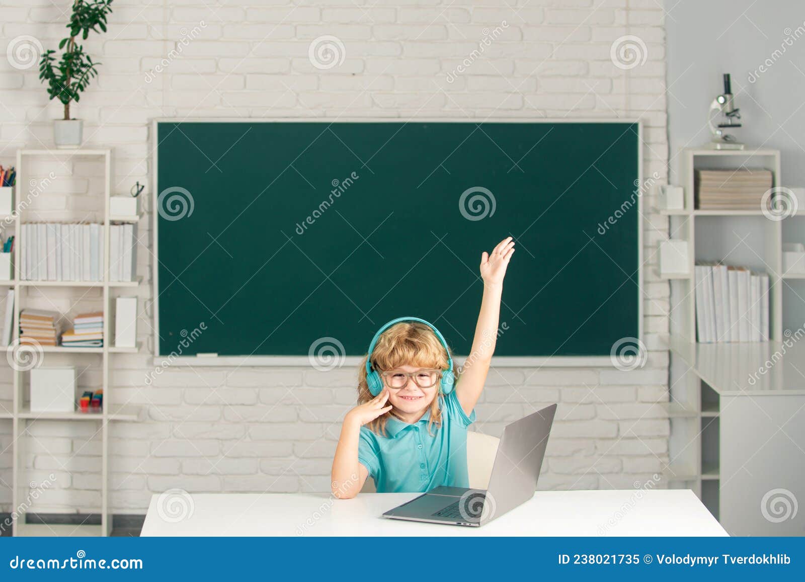 Cute Little School Kid Boy with Raised Hand Study in a Classroom. Stock ...