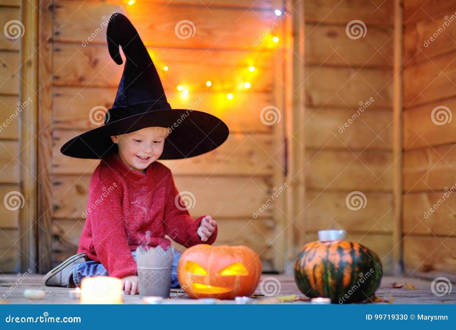 Cute Little Wizard with Magic Wand and Jack-o-lanterns Stock Photo ...