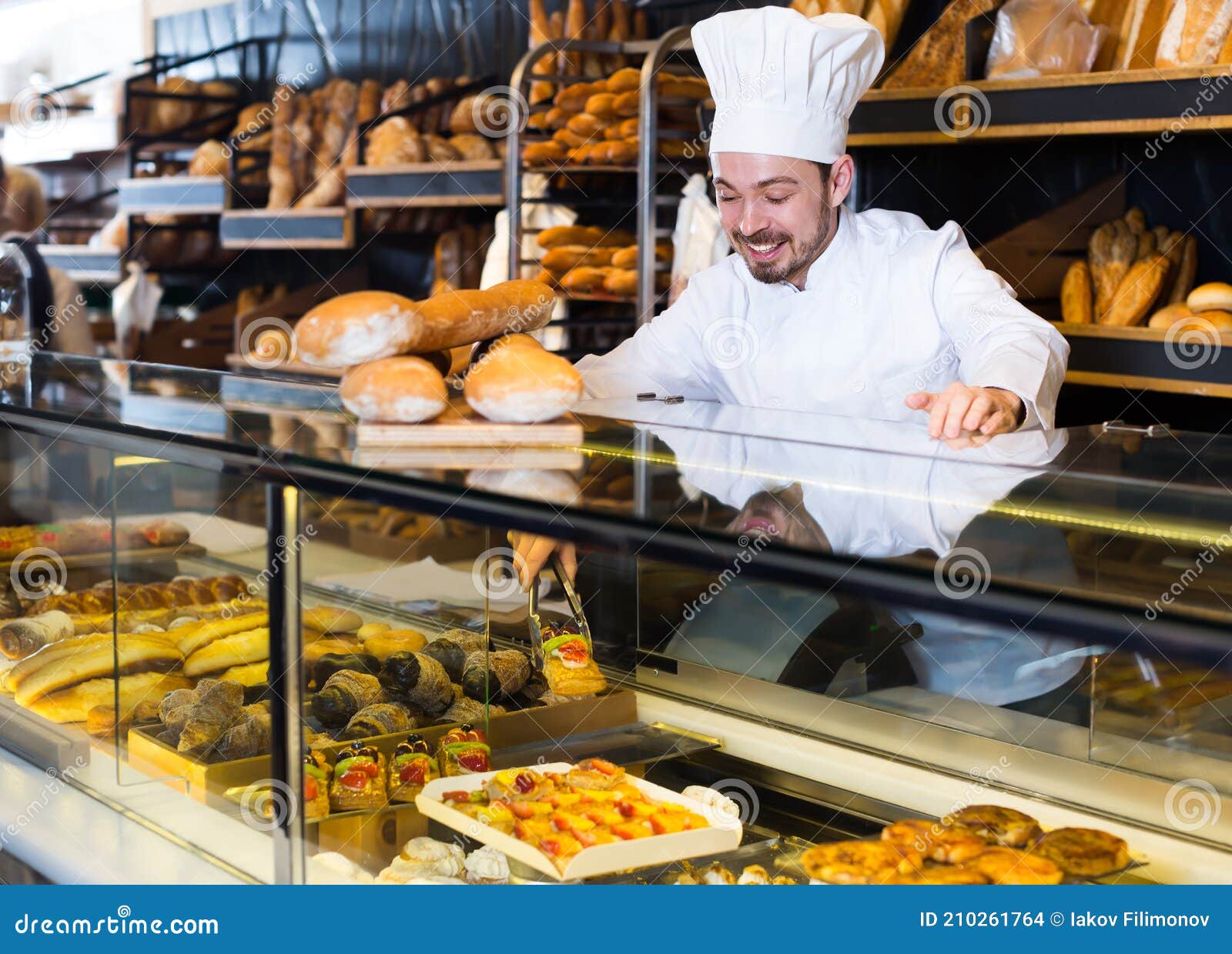 Cute Baker Showing Assortment of Bakery Stock Photo - Image of ...