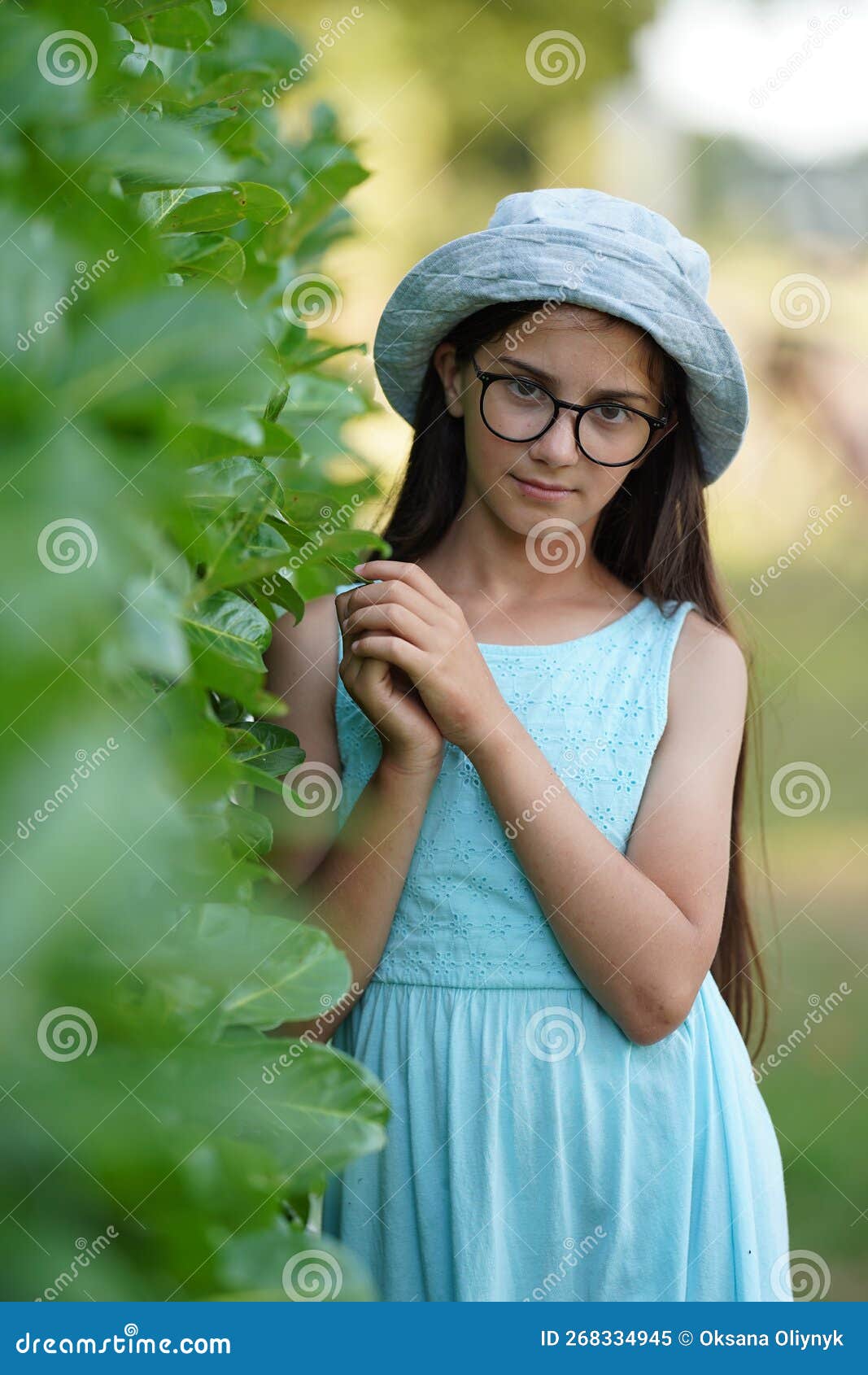 A Cute Modest Girl in Glasses and a Simple Dress Gently Touches the ... A Cute Modest Girl in Glasses and a Simple Dress Gently Touches the ...