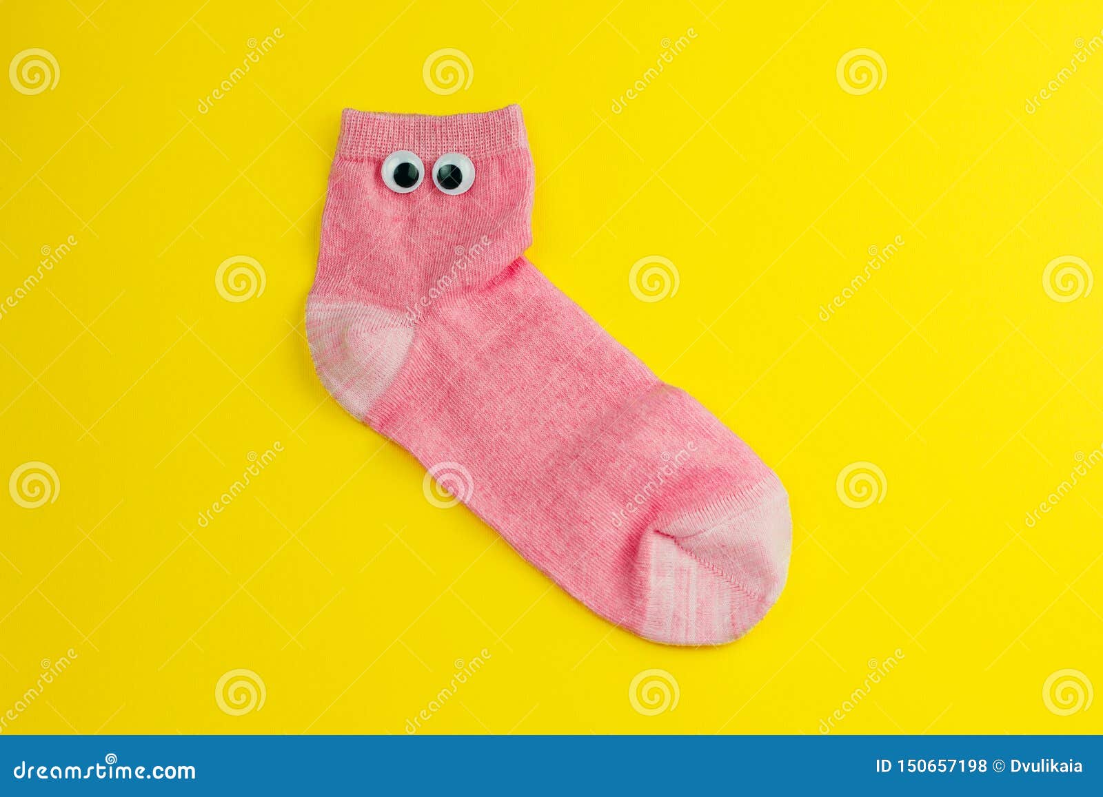 Pink Sock with Googly Eyes Isolated on Yellow Background Stock Photo ...