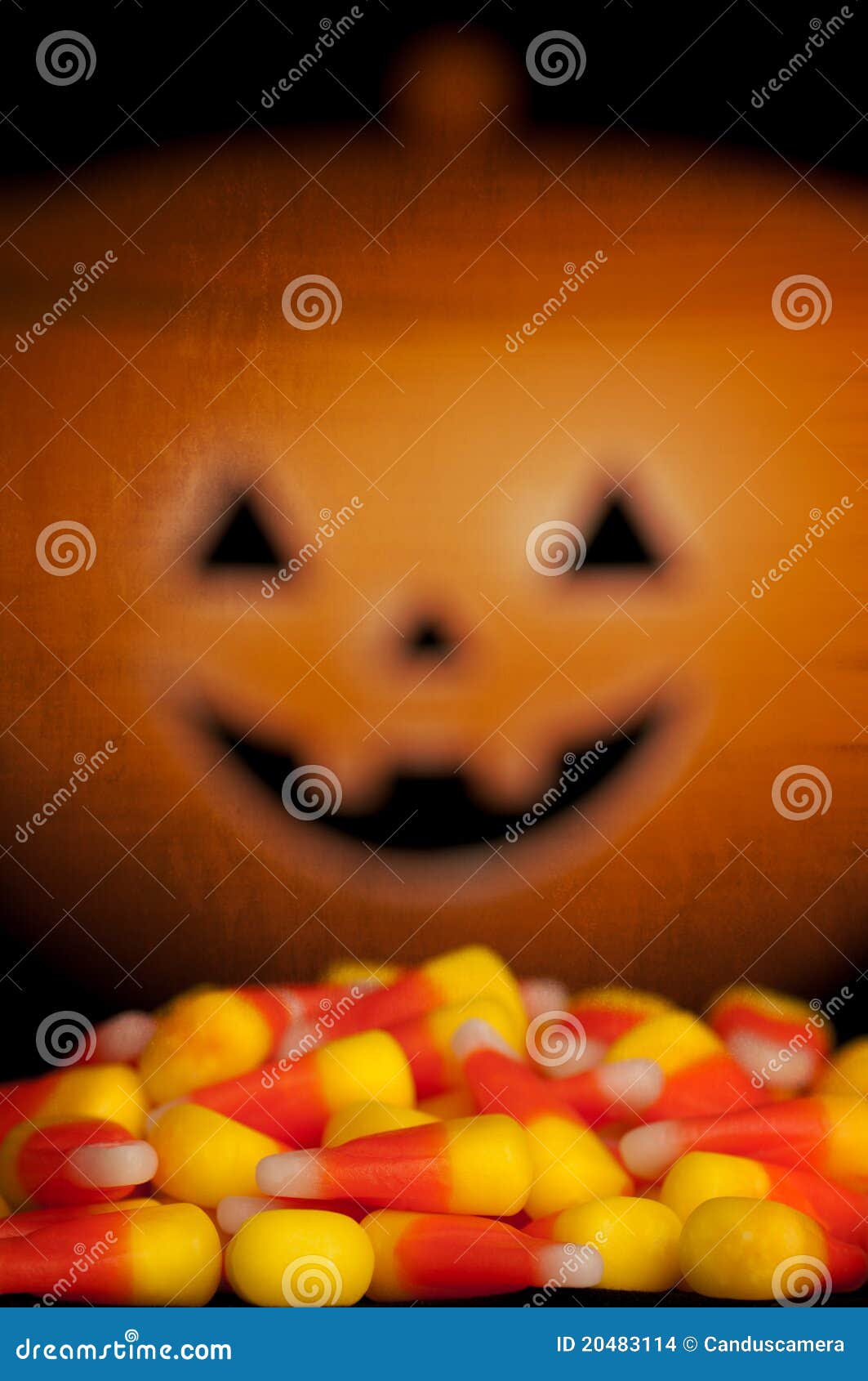 Cute Pumpkin Smiling Over Candy Corn Stock Photo - Image of candy, dark ...