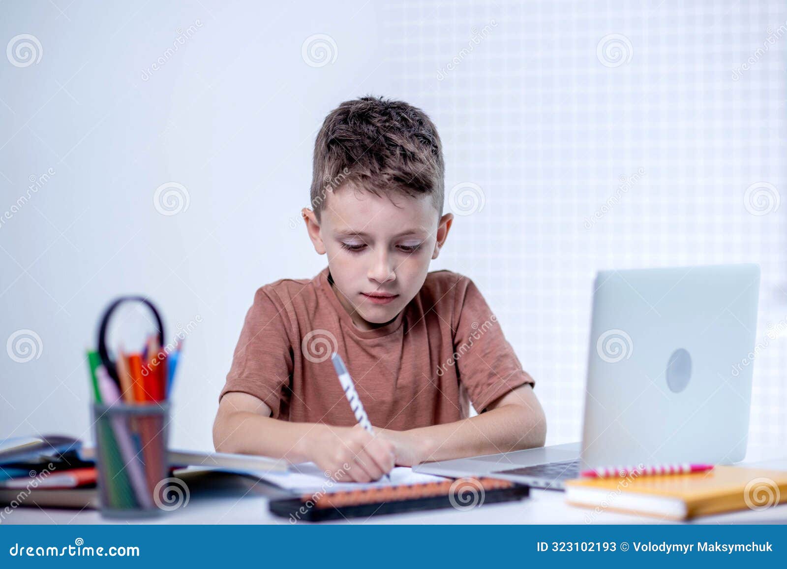 Cute Pupil Boy Studying at Home Writing in Exercise Book Doing Homework ...