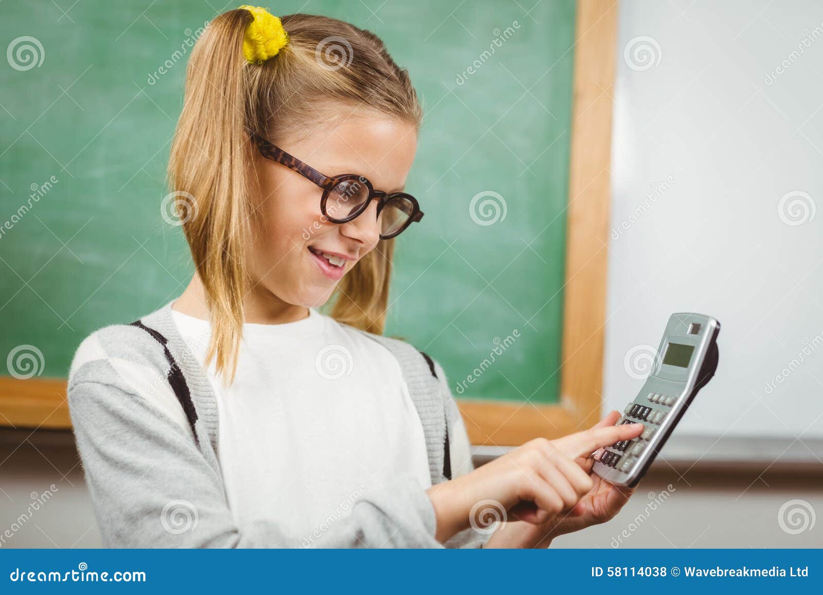 Cute Pupil Calculating with Calculator in a Classroom Stock Photo ...