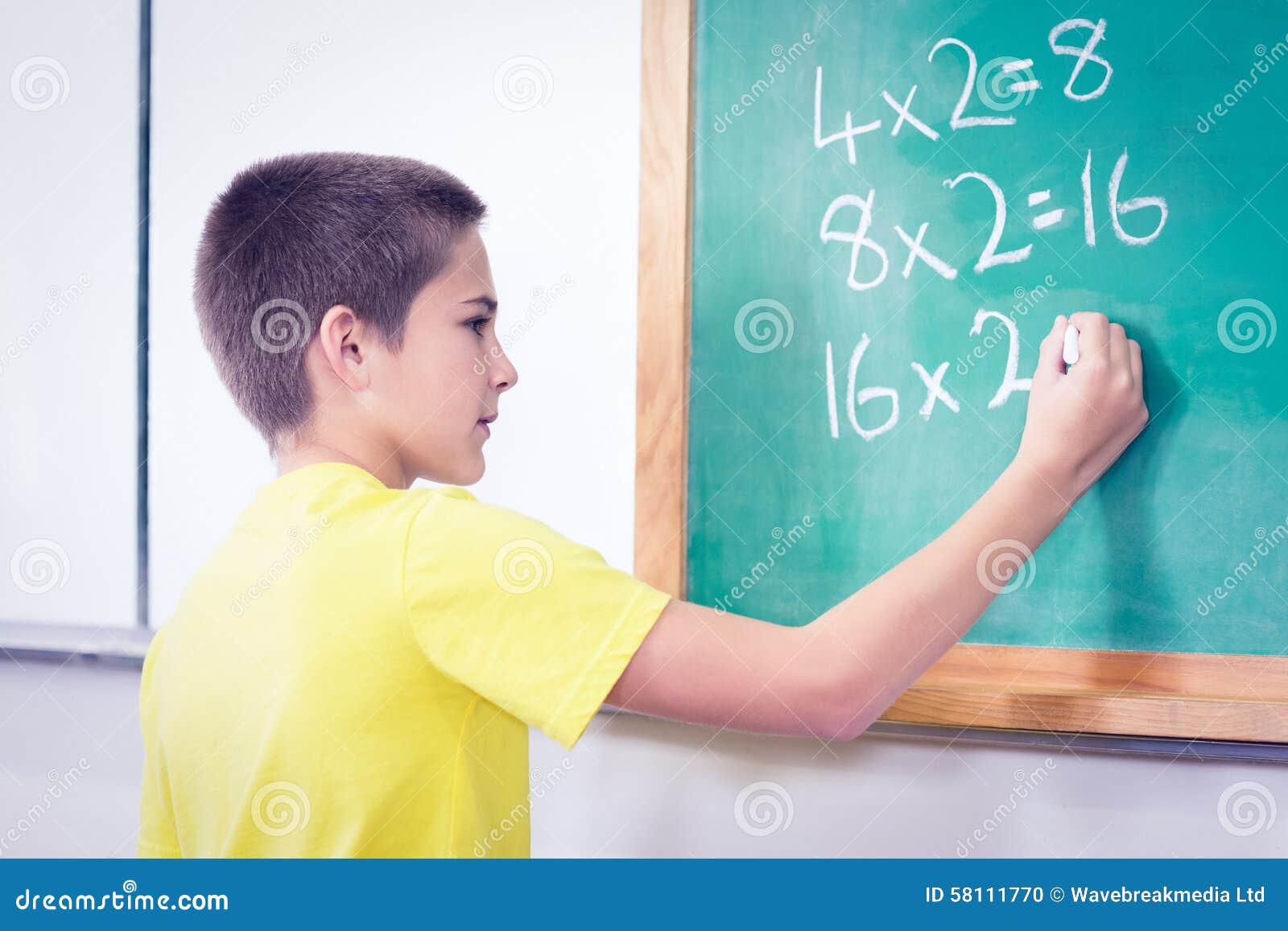 Cute Pupil Calculating on Chalkboard in a Classroom Stock Photo - Image ...