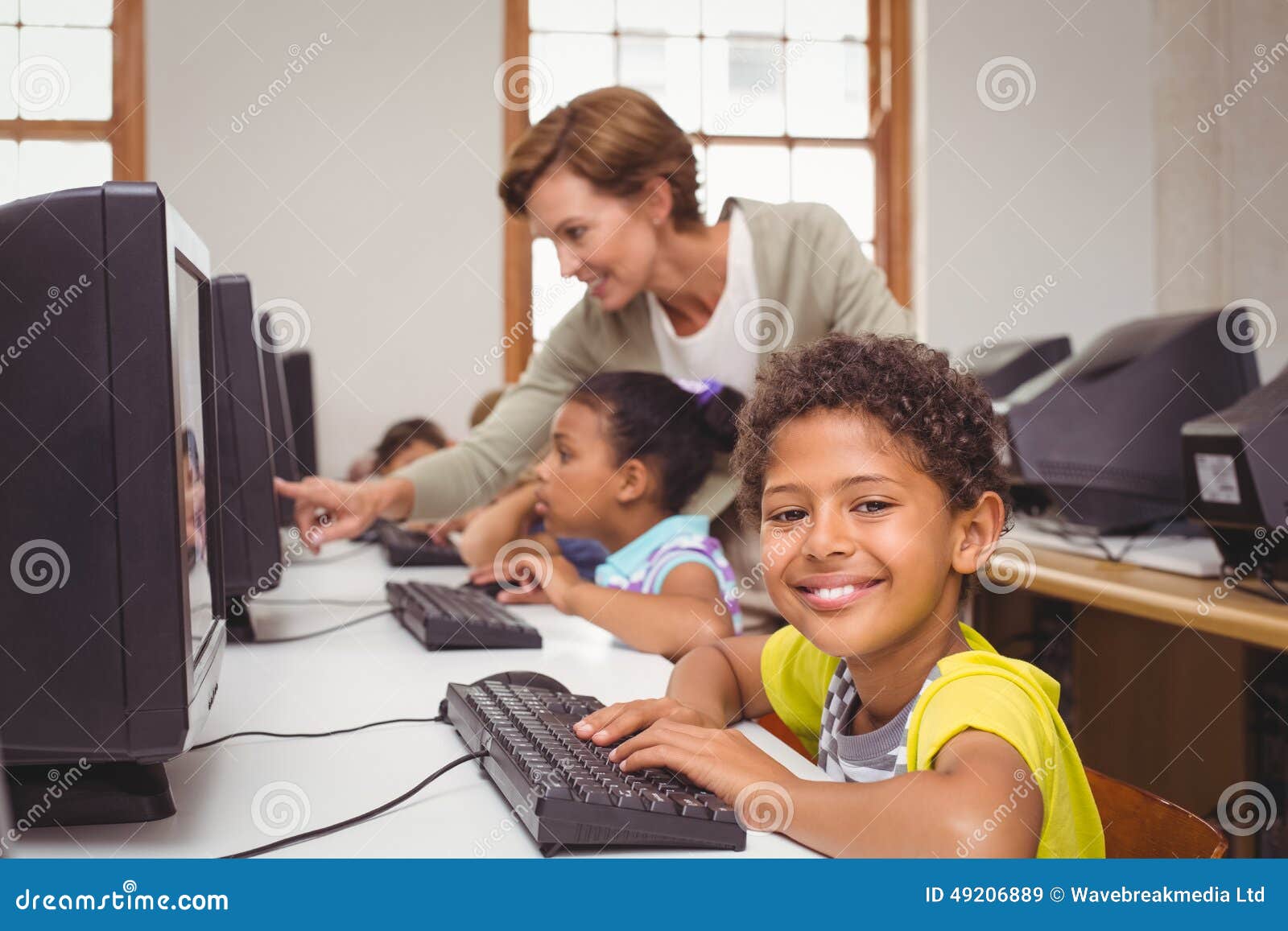 Cute Pupil in Computer Class Smiling at Camera Stock Image - Image of ...