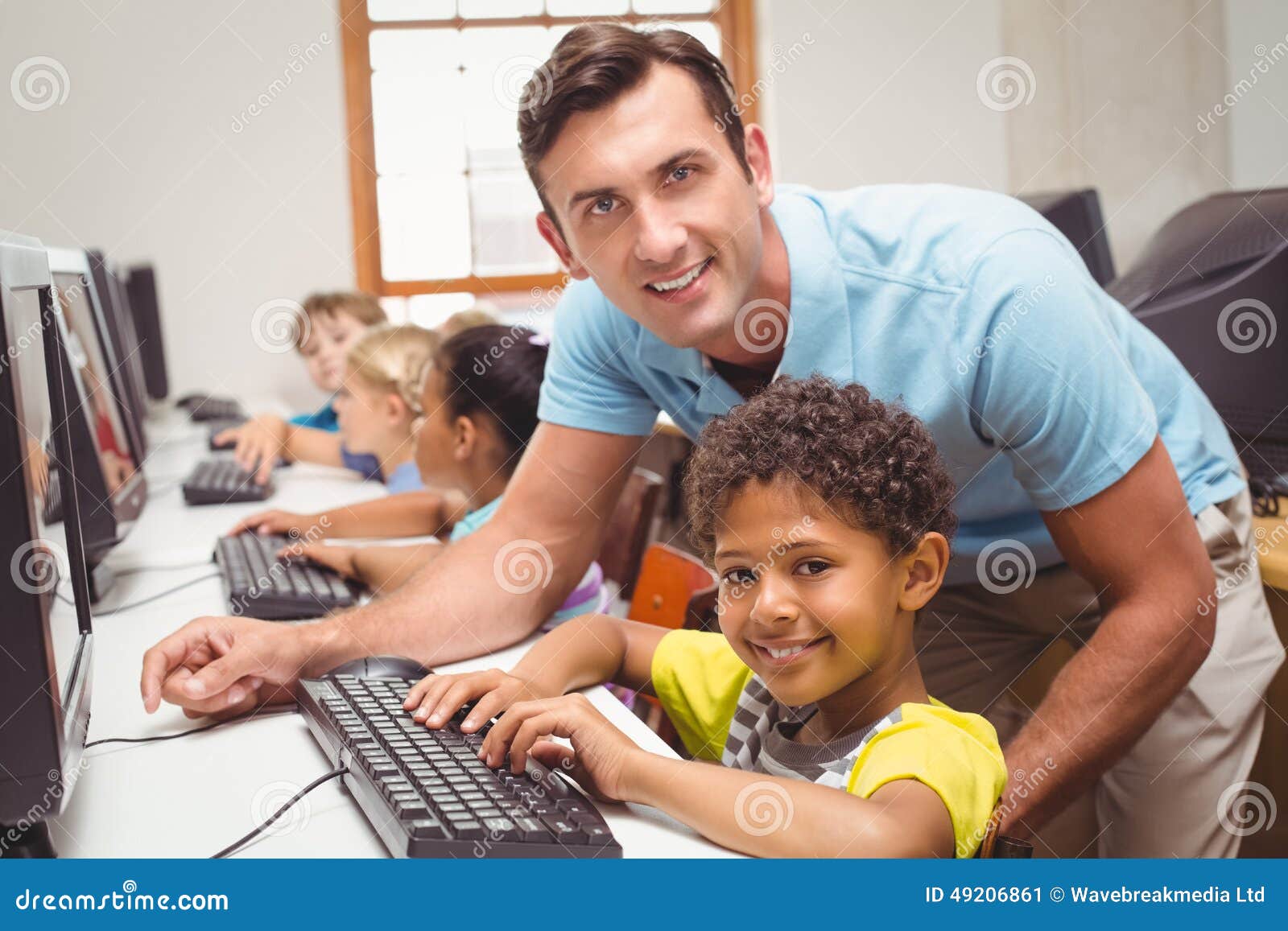 Cute Pupil in Computer Class with Teacher Smiling at Camera Stock Image ...