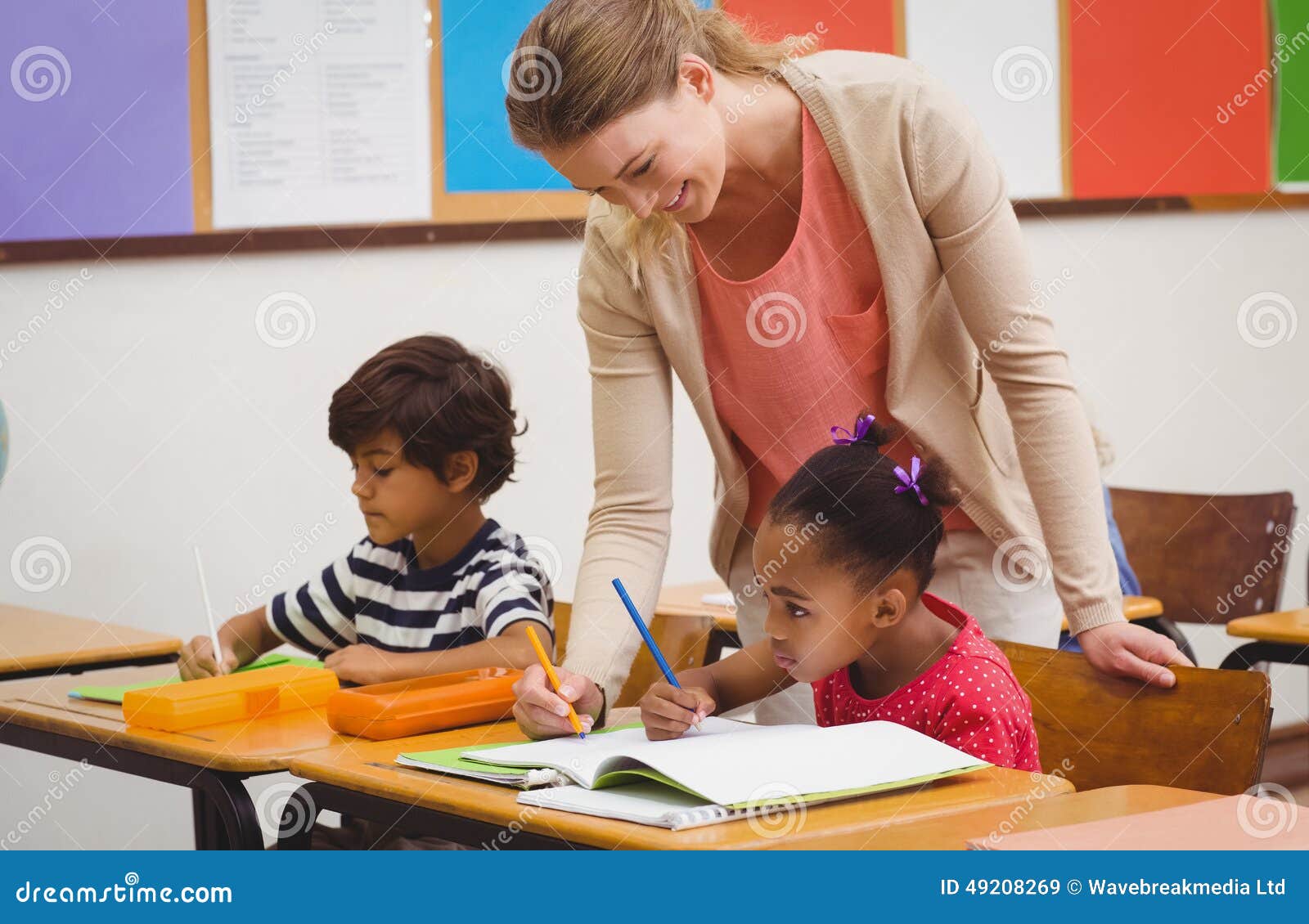 Cute Pupil Getting Help from Teacher in Classroom Stock Image - Image ...