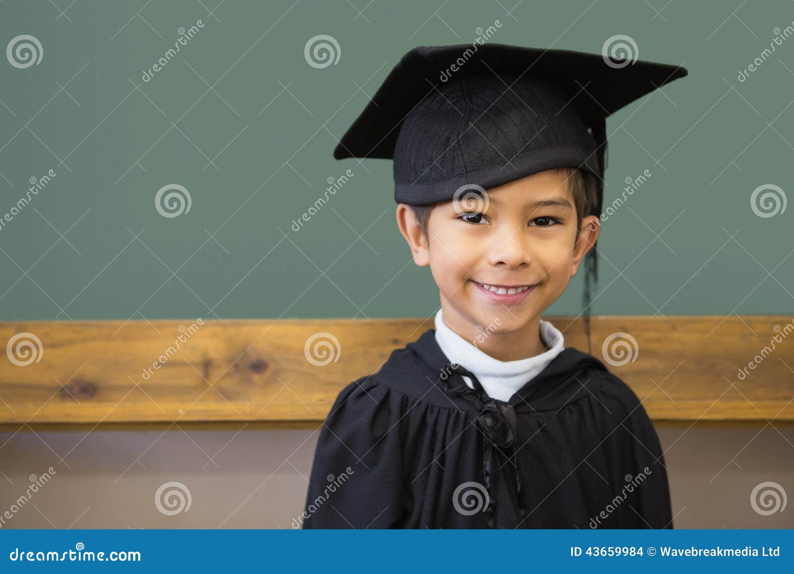 Cute Pupil in Graduation Robe Smiling at Camera in Classroom Stock ...