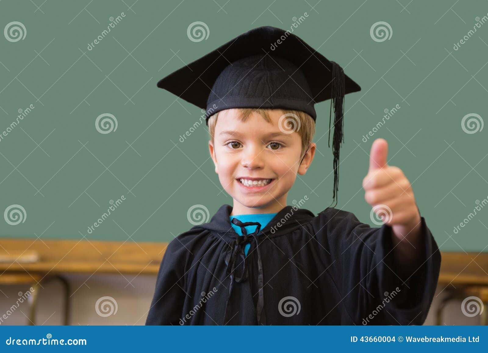 Cute Pupil in Graduation Robe Smiling at Camera in Classroom Stock ...