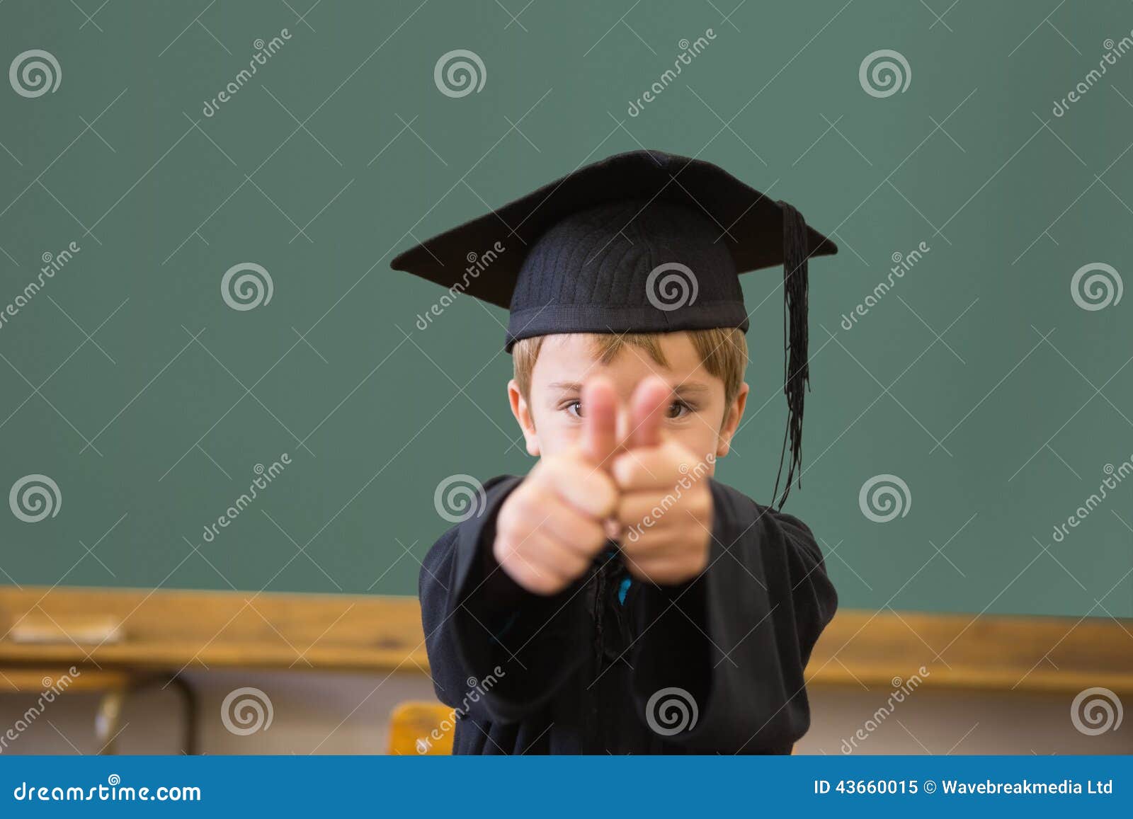 Cute Pupil in Graduation Robe Smiling at Camera in Classroom Stock ...