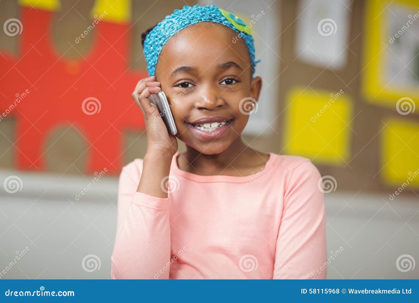 Cute Pupil Phoning with Smartphone in a Classroom Stock Photo - Image ...