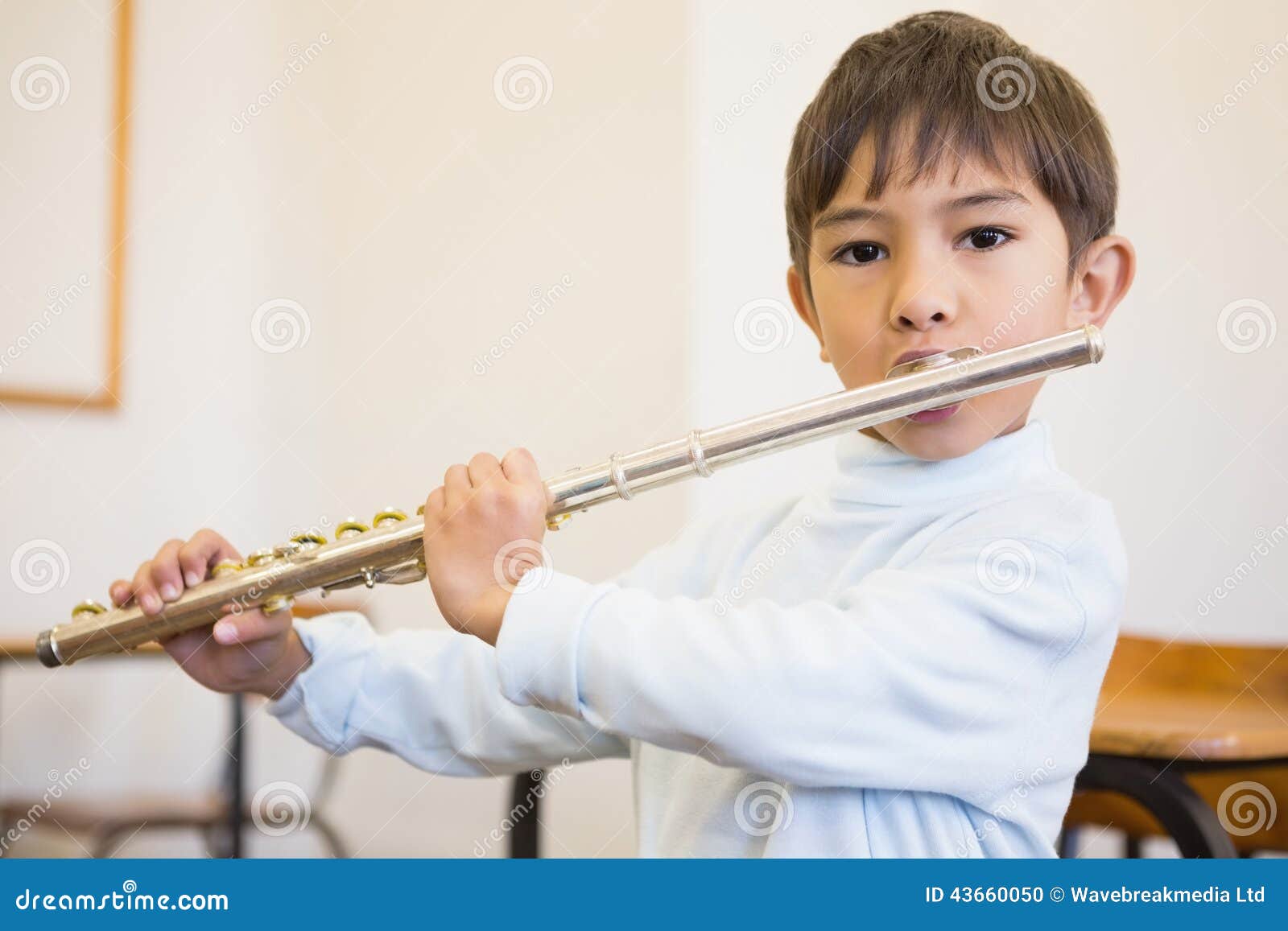 Cute Pupil Playing Flute in Classroom Stock Photo - Image of front ...