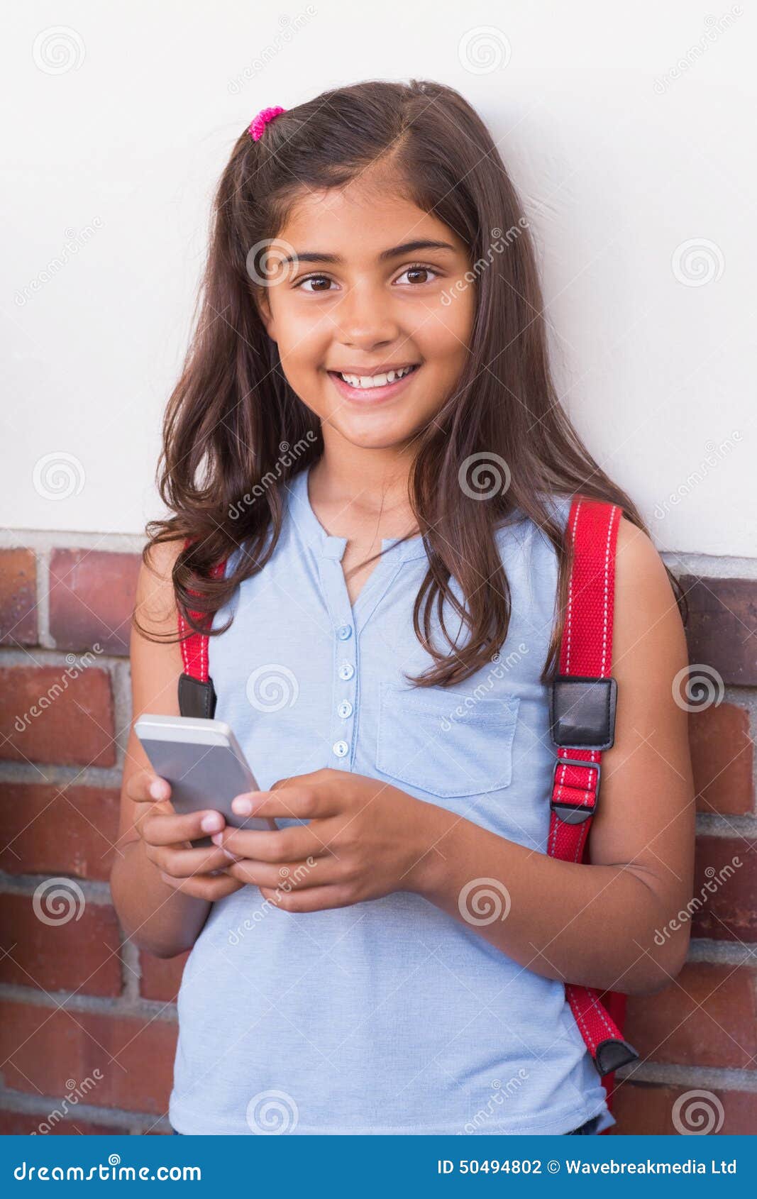 Cute Pupil Using Mobile Phone Stock Photo - Image of back, happy: 50494802