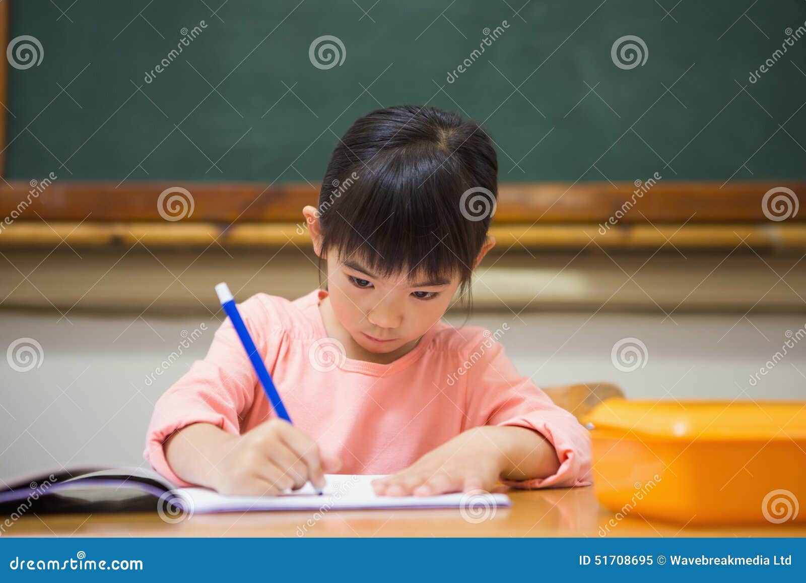 Cute Pupil Writing at Desk in Classroom Stock Image - Image of ...