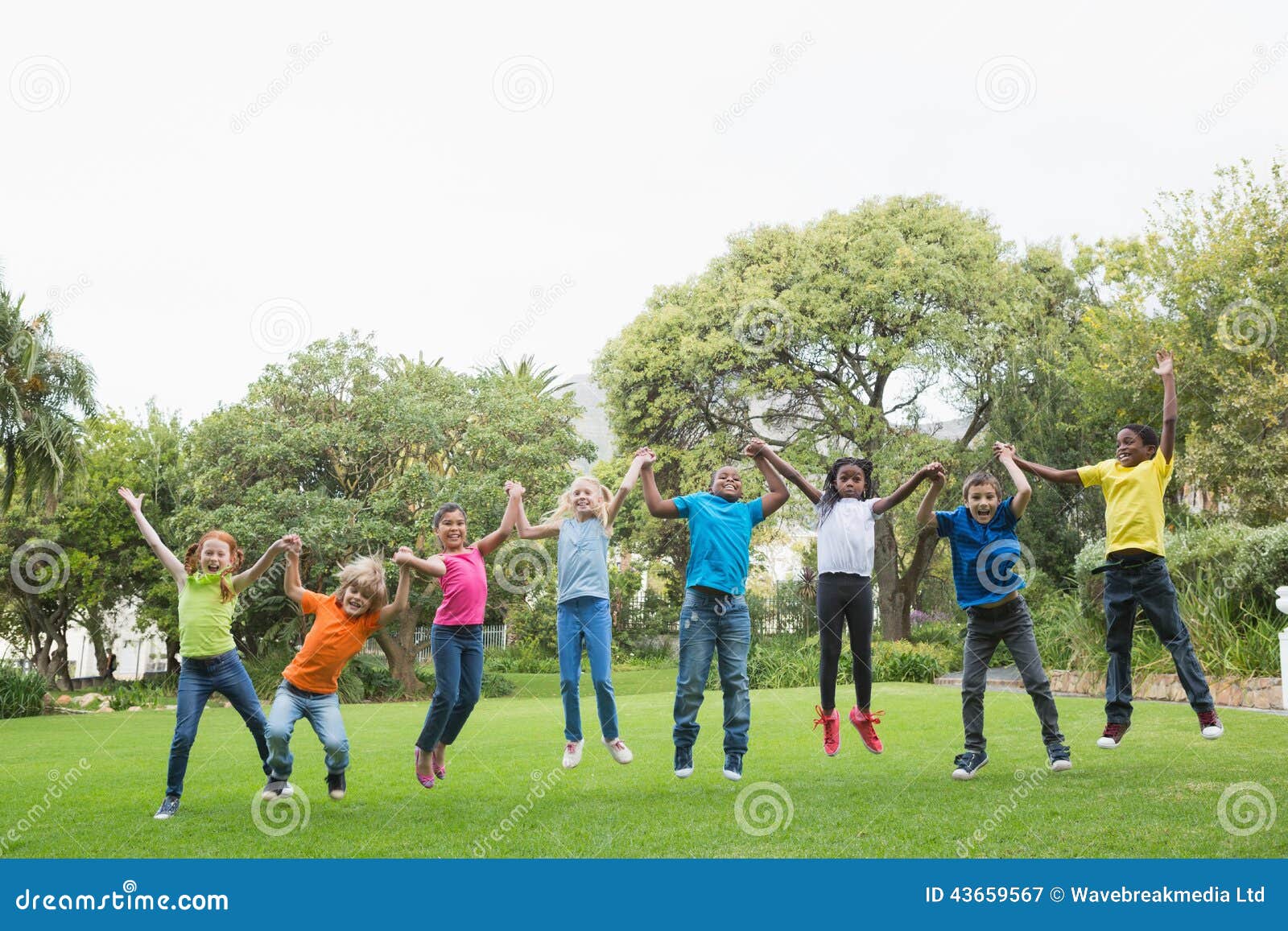 Cute Pupils Jumping on the Grass Outside Stock Image - Image of medium ...
