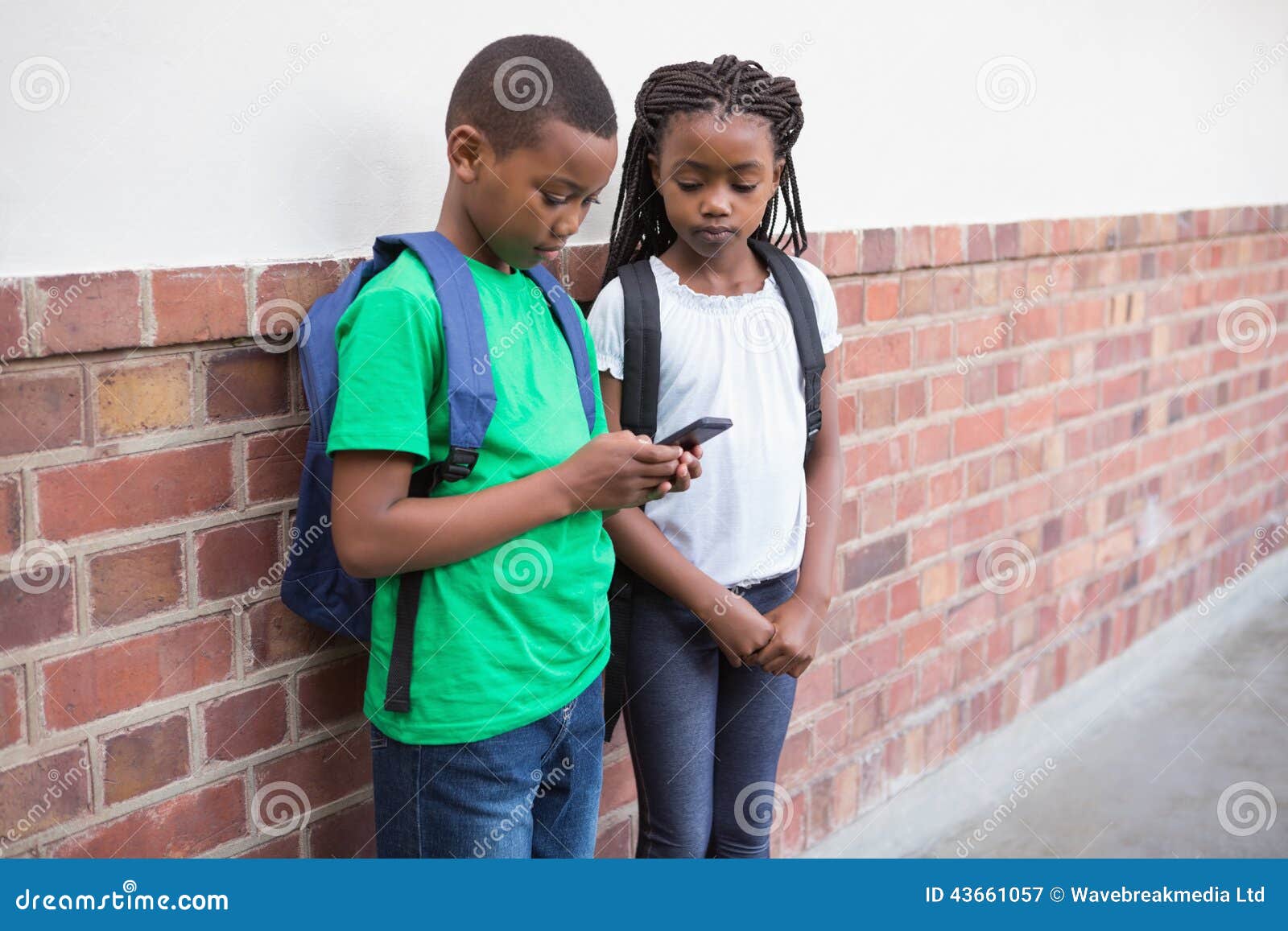 Cute Pupils Looking at Smartphone in Corridor Stock Image - Image of ...