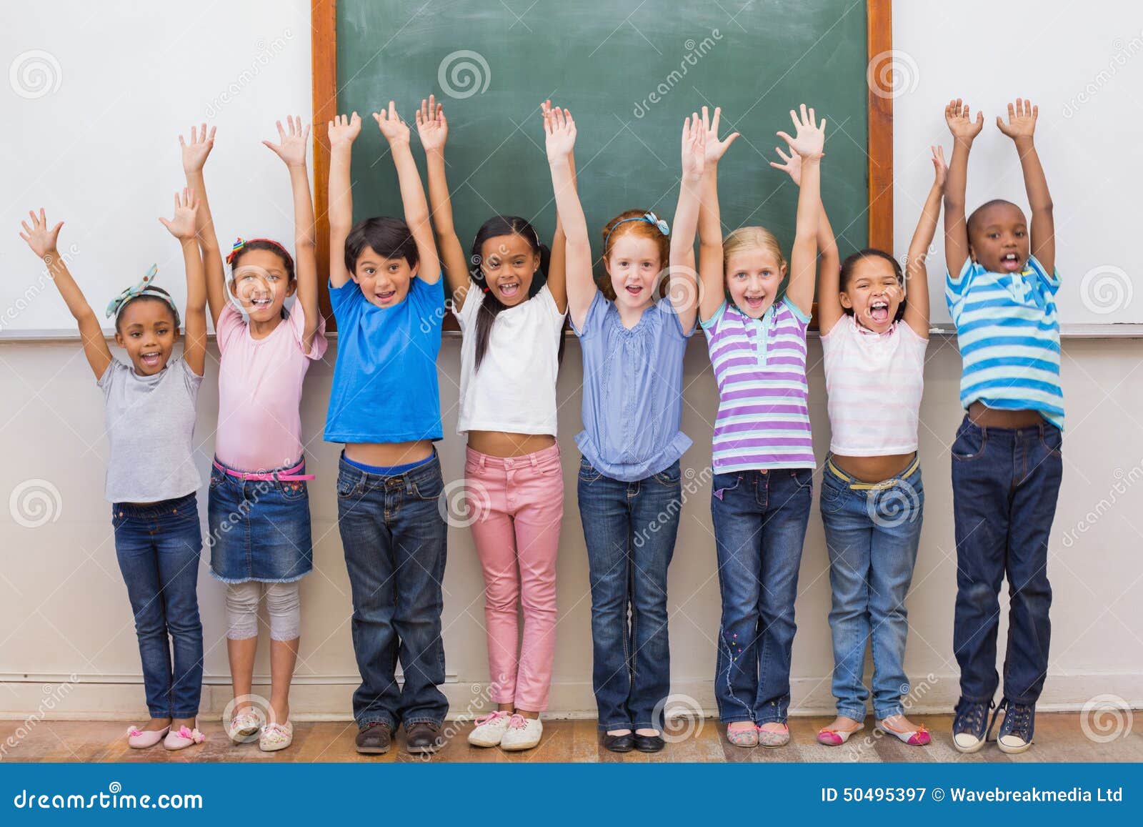 Cute Pupils Smiling at Camera in Classroom Stock Image - Image of ...