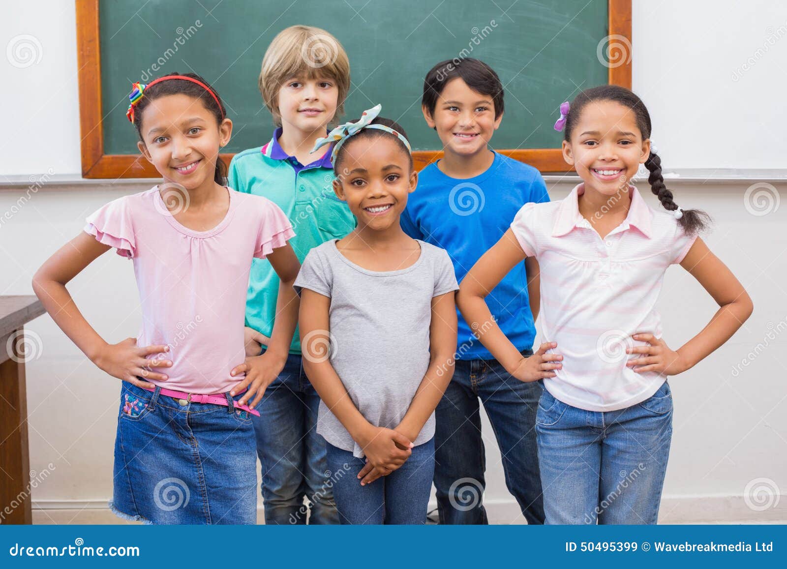 Cute Pupils Smiling at Camera in Classroom Stock Image - Image of five ...