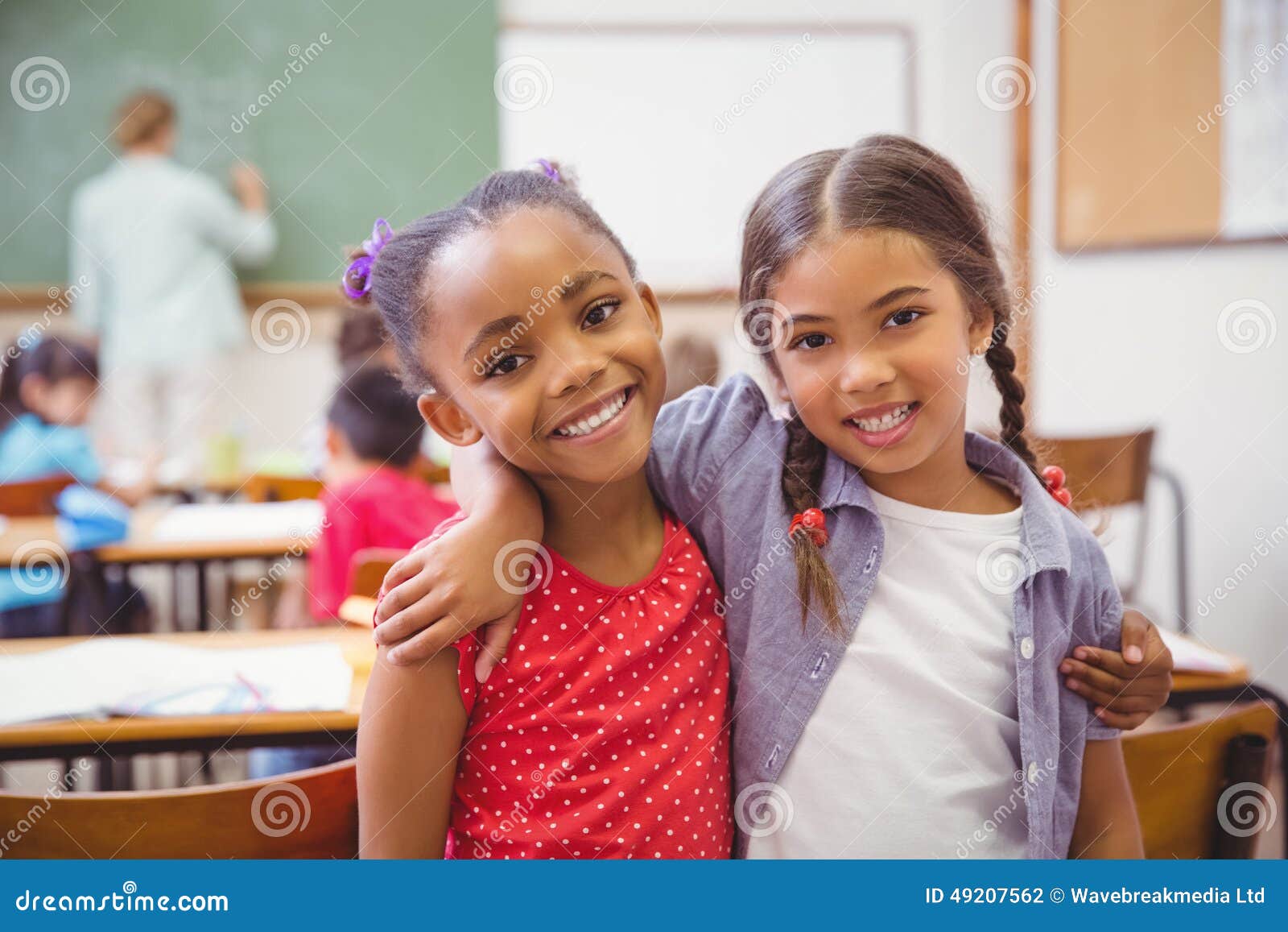 Cute Pupils Smiling at Camera in Classroom Stock Photo - Image of ...