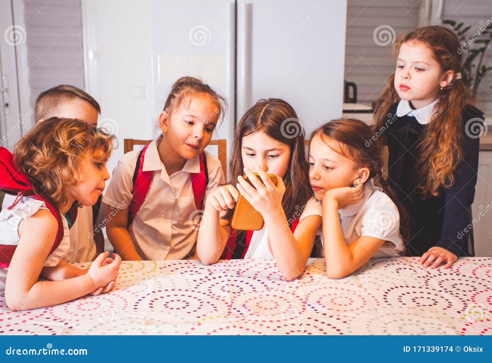 Cute Pupils Talking and Using Smartphone during Break. Happy Friends ...