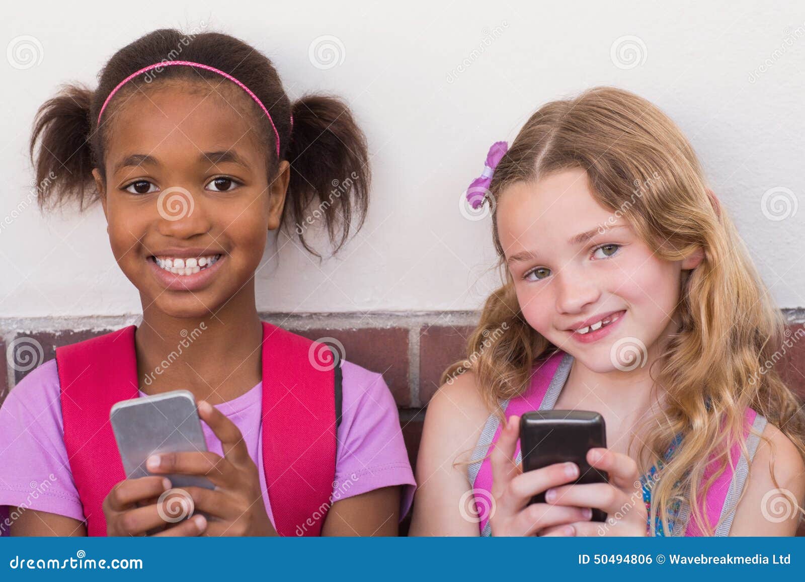 Cute Pupils Using Mobile Phone Stock Photo - Image of learning, phone ...