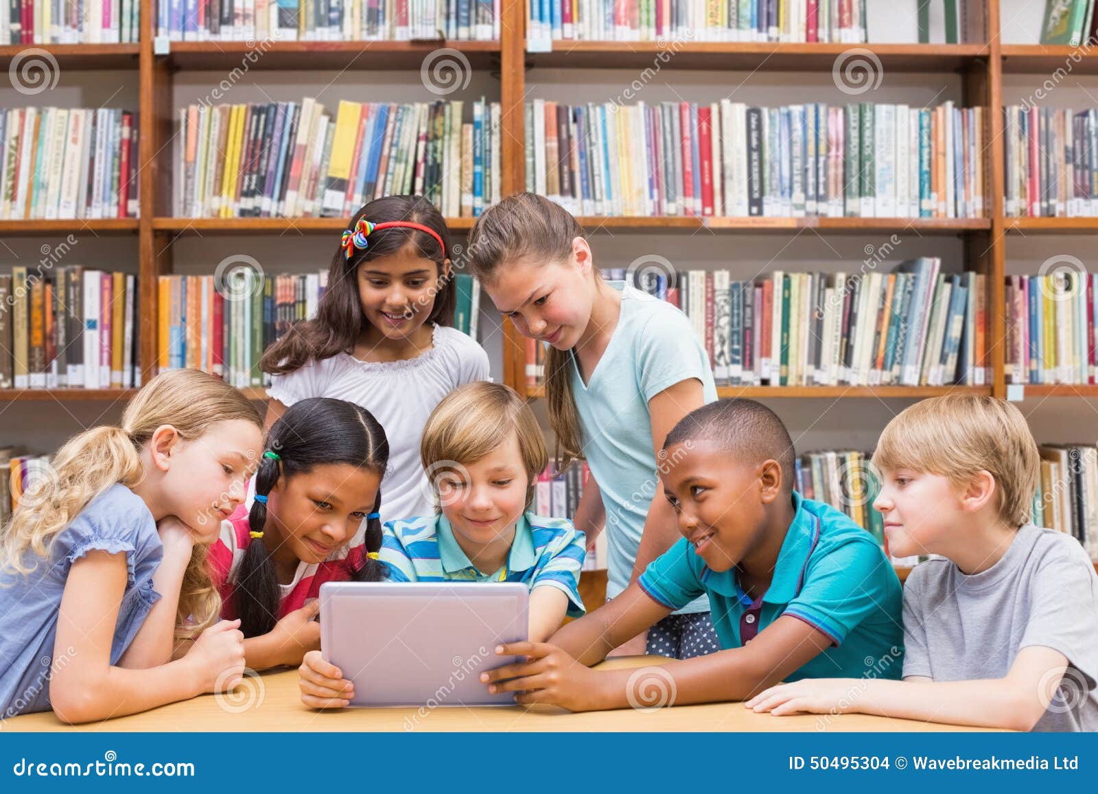 Cute Pupils Using Tablet Computer in Library Stock Photo - Image of ...