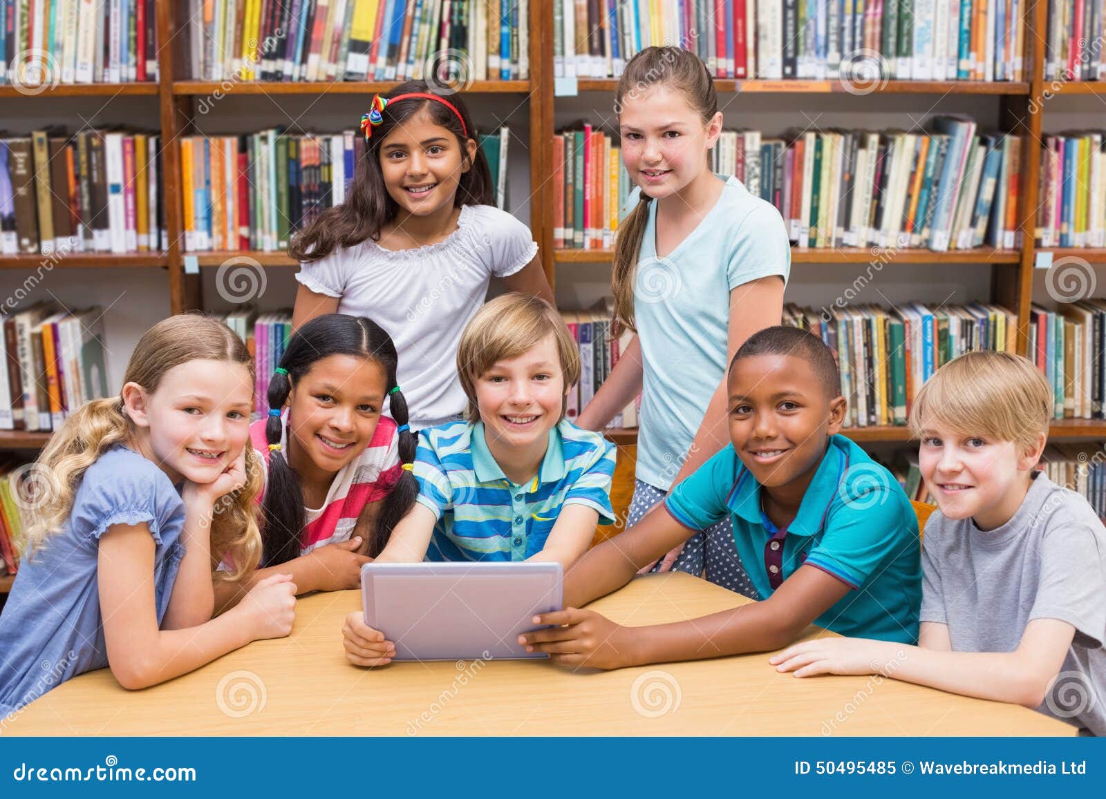 Cute Pupils Using Tablet Computer in Library Stock Image - Image of ...