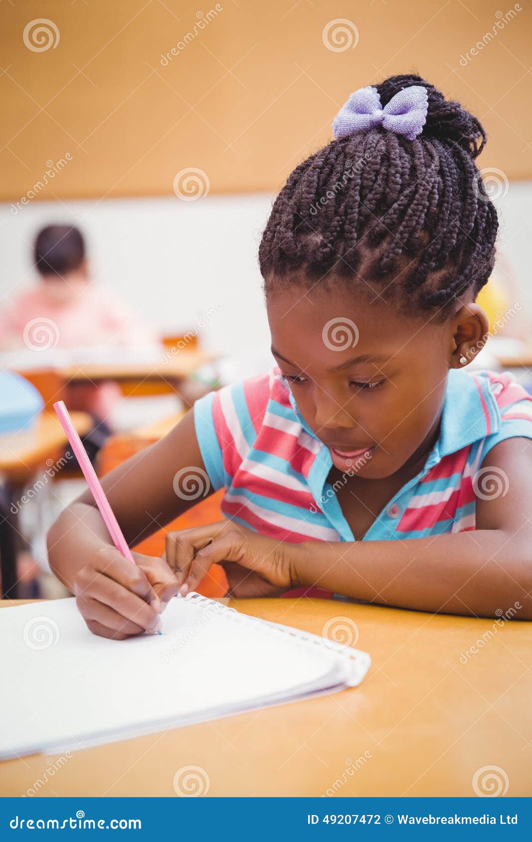 Cute Pupils Writing at Desk in Classroom Stock Photo - Image of ...