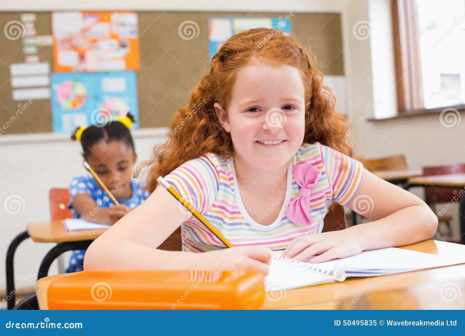 Cute Pupils Writing at Desk in Classroom Stock Image - Image of learn ...