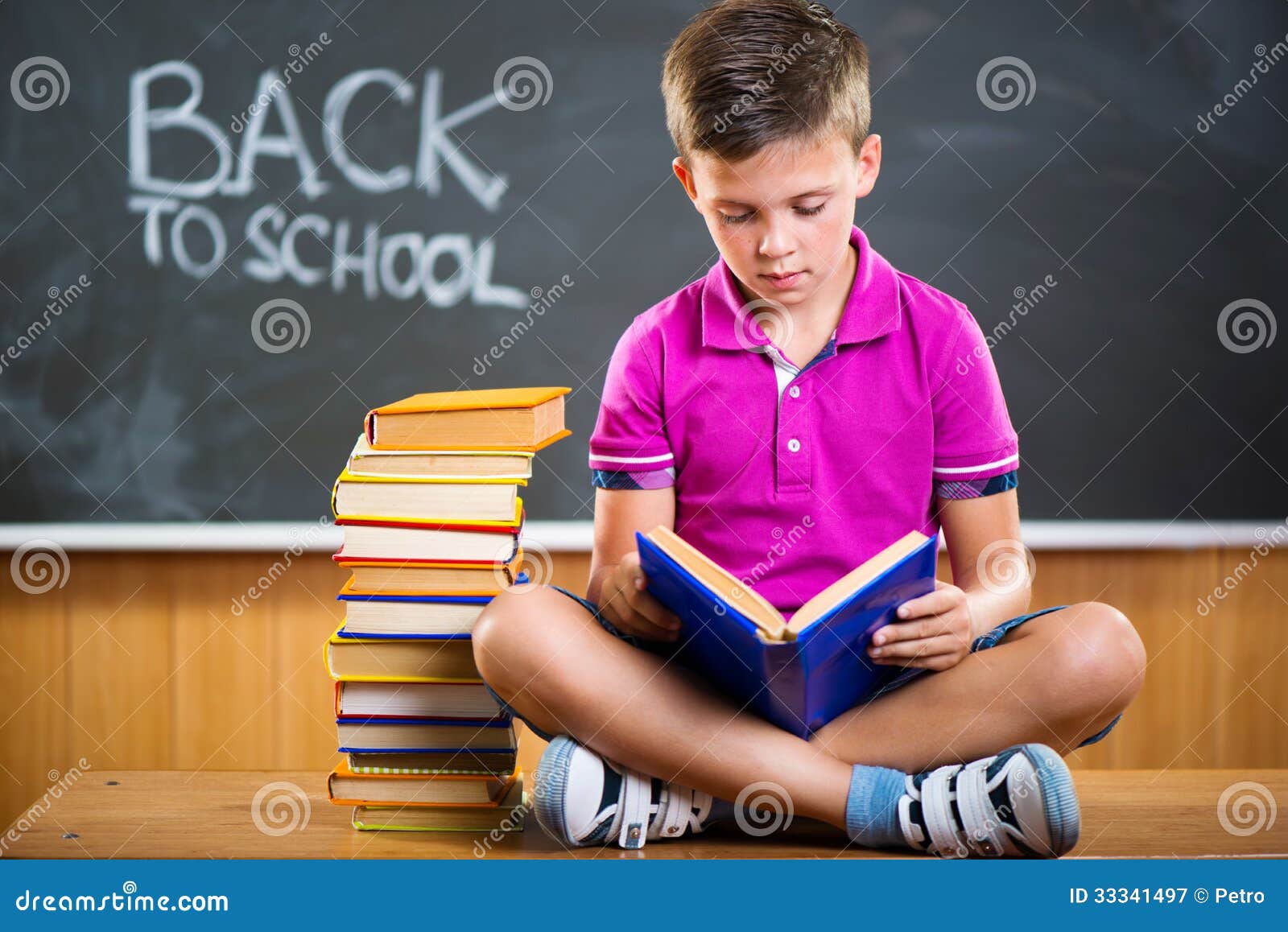 Cute School Boy Reading Book in Classroom Stock Image - Image of desk ...