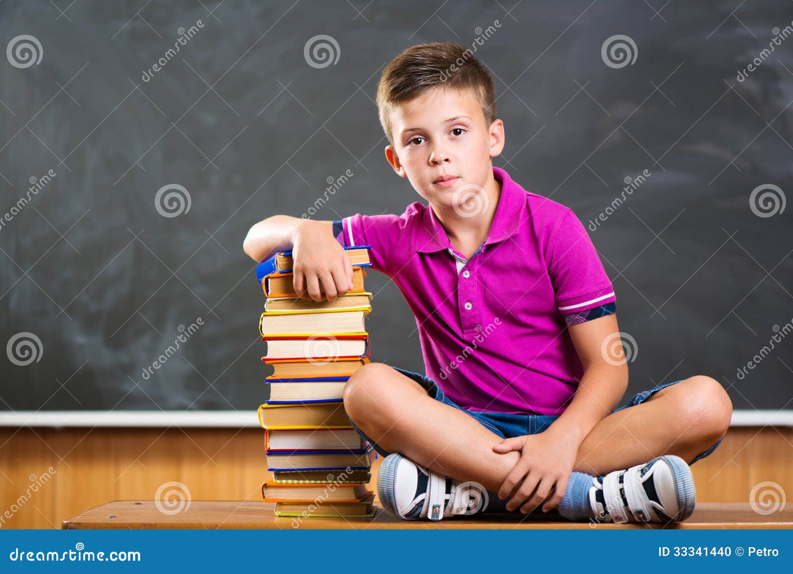 Cute School Boy Sitting with Books in Classroom Stock Photo - Image of ...