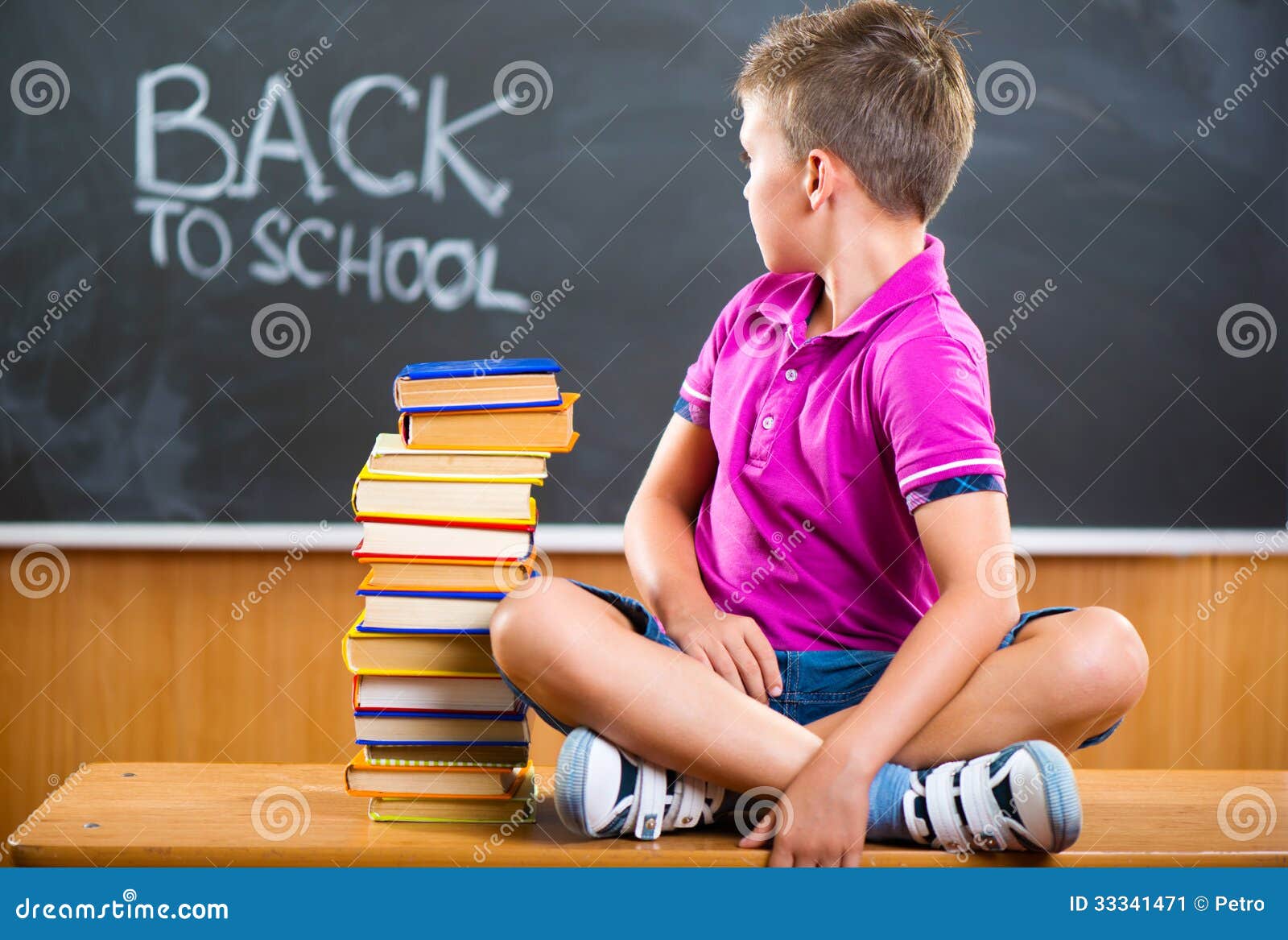 Cute School Boy Sitting with Books in Classroom Stock Image - Image of ...