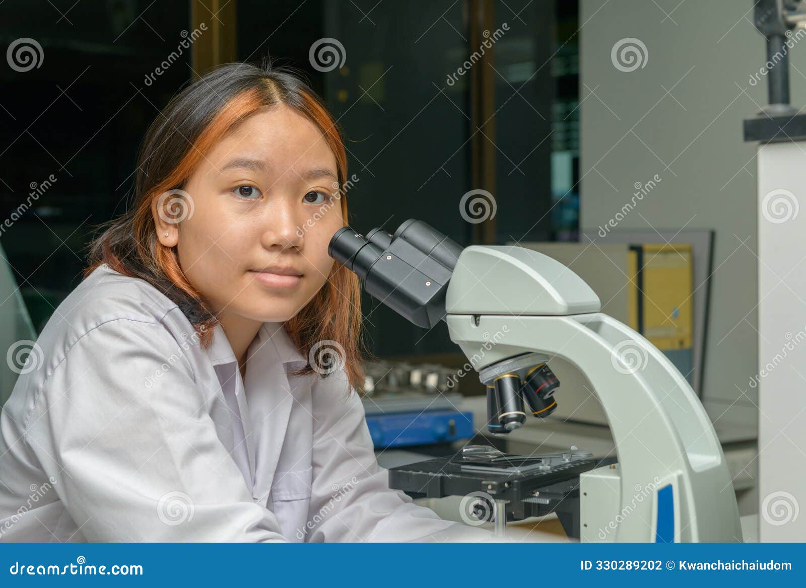 Cute Scientist Schoolgirl In Lab Coat Looks Through Microscope For ...