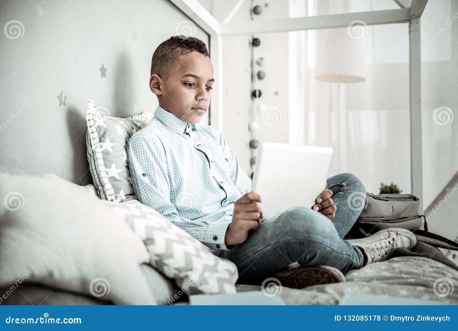 Cute Serious Boy Looking at the Tablet Screen Stock Photo - Image of ...