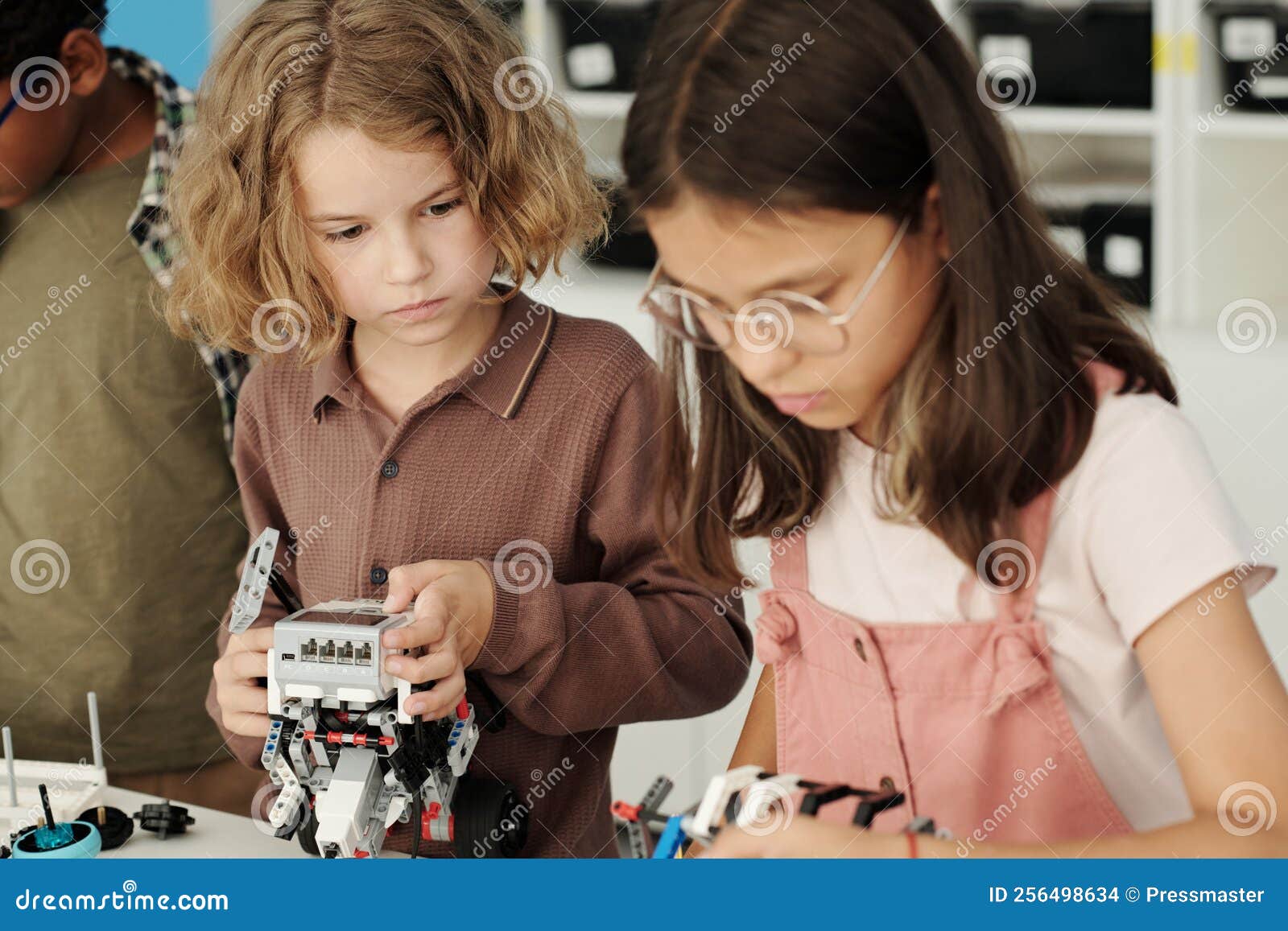 Cute Sesrious Schoolboy Looking at His Classmate Constructing Robot at ...